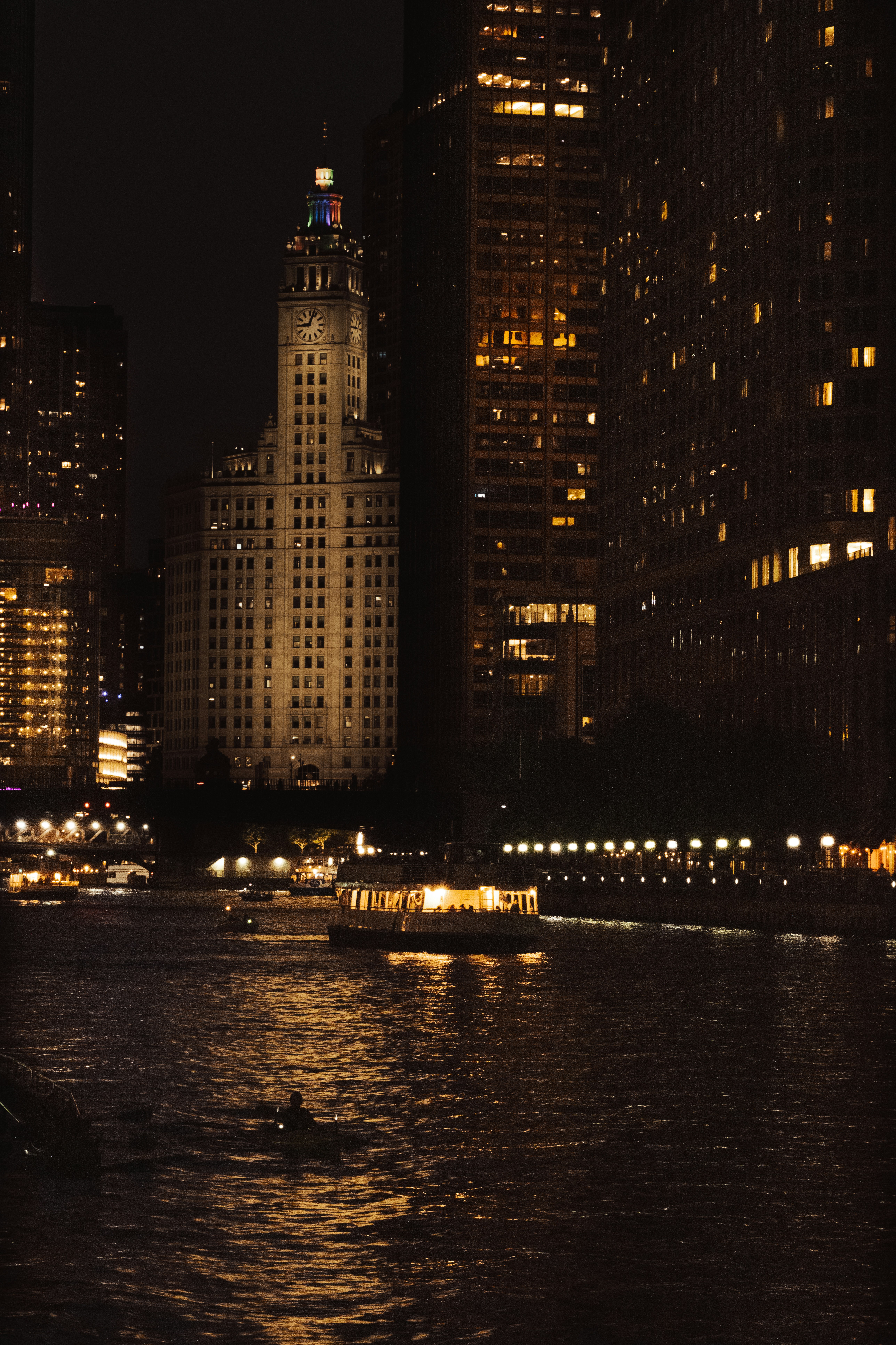 Midnight River Run: A Lanterned Ferry Against the Skyscraper Night