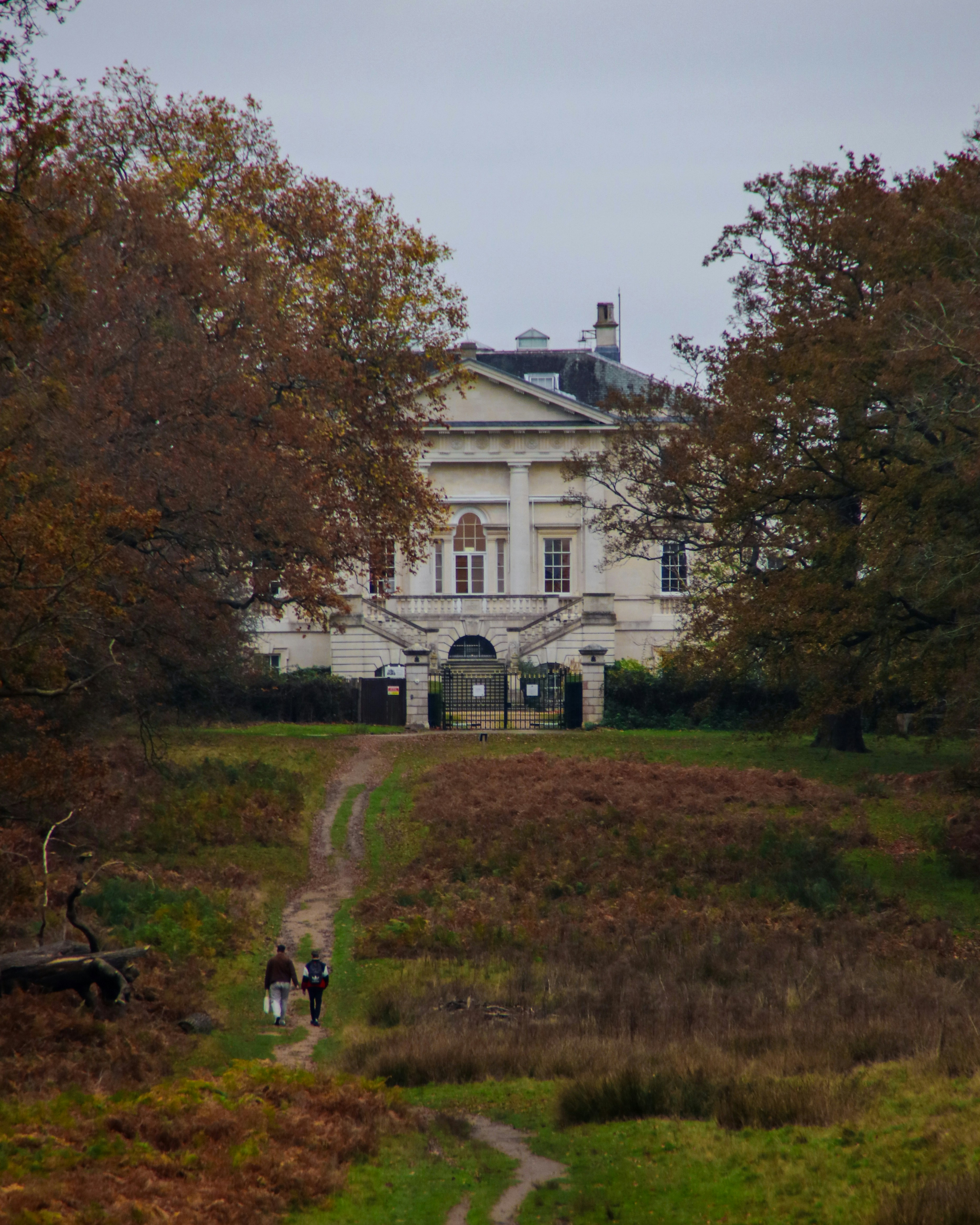 The Gatehouse at Dusk: A Path Through the Park to a Stately Manor