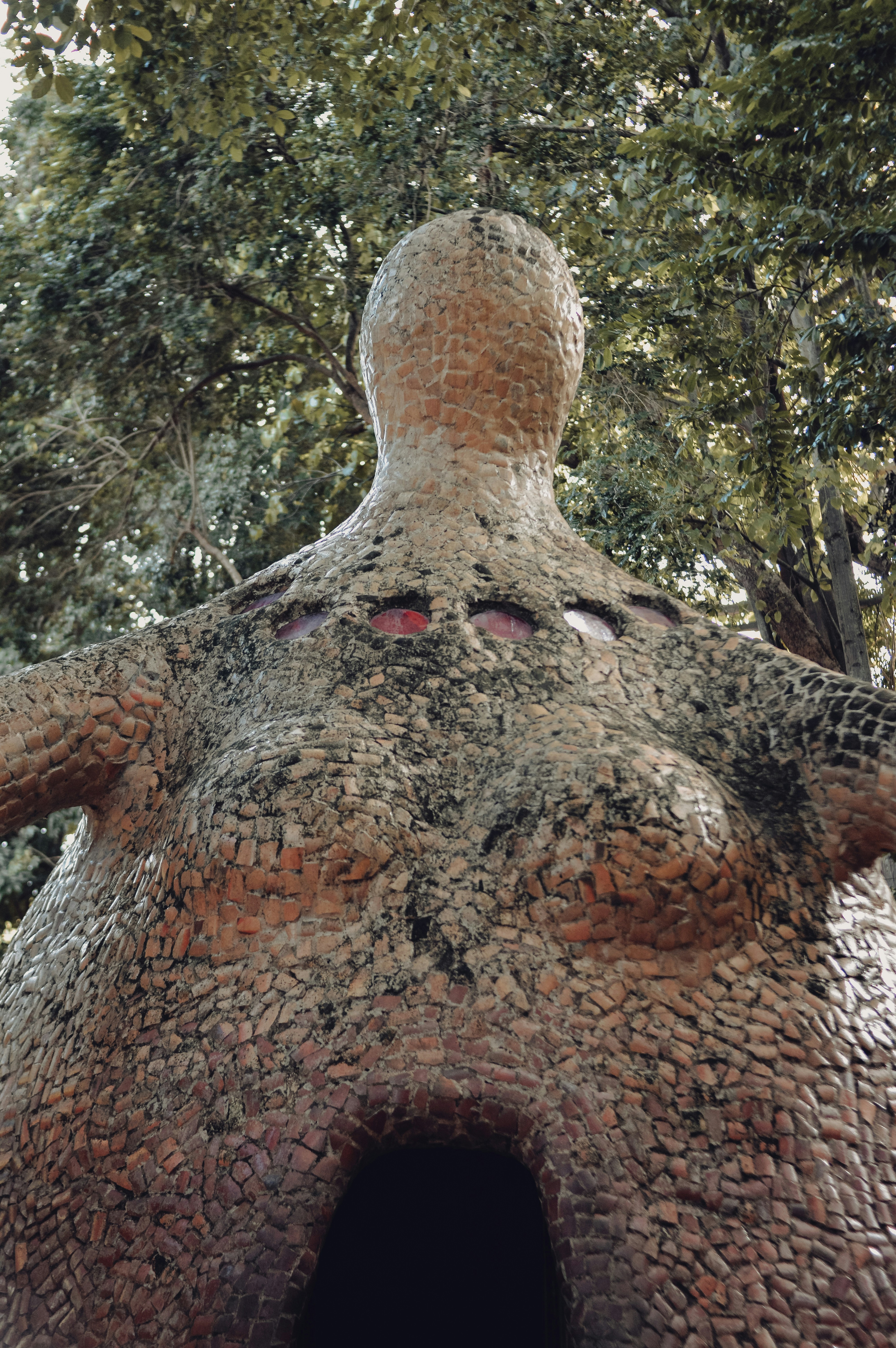 Stone Mosaic: The Back-View Figure Emerges from Moss and Leaves