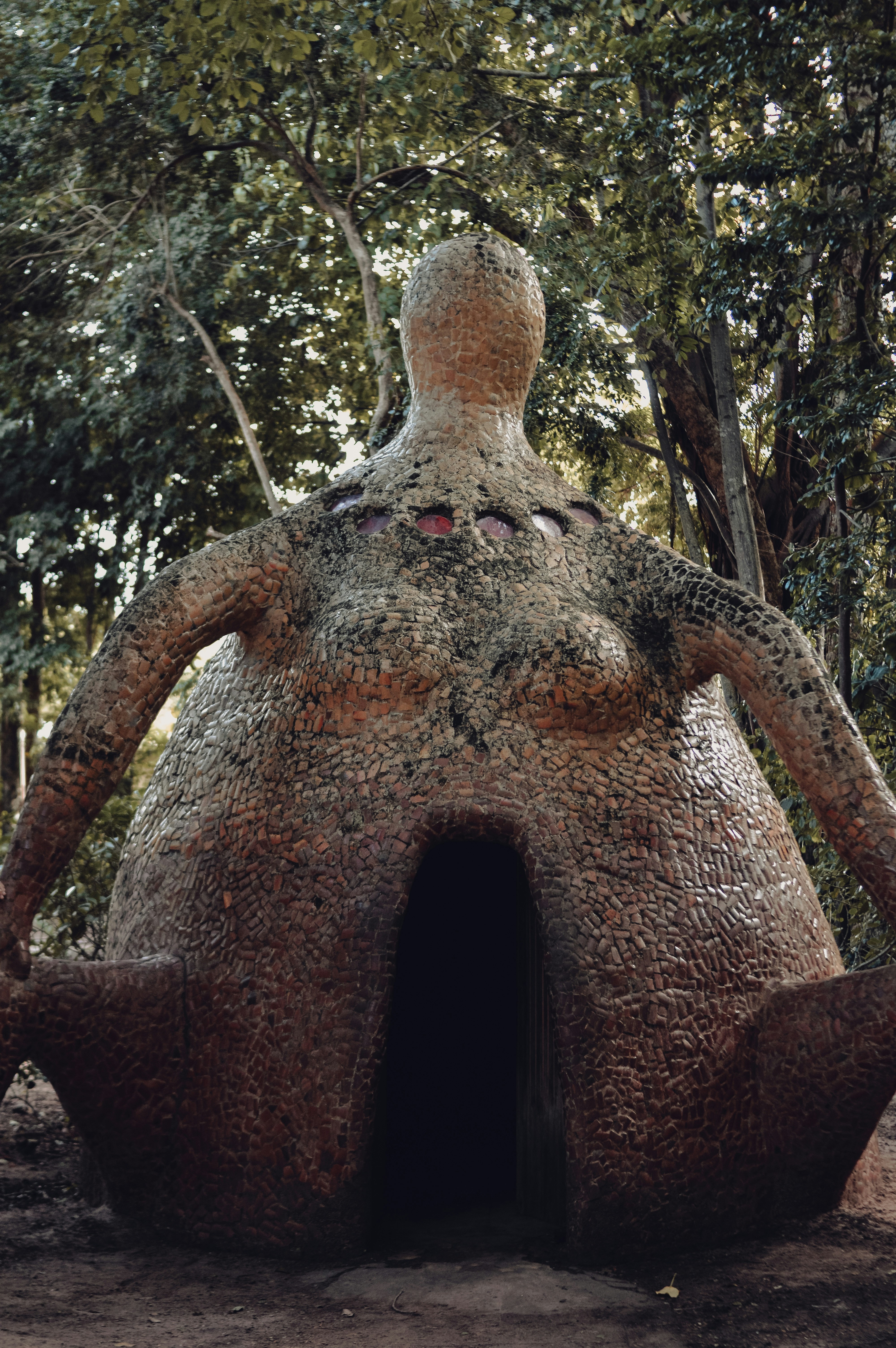 Emergence of a Stone Sentinel: A Sculpted Figure Among the Trees
