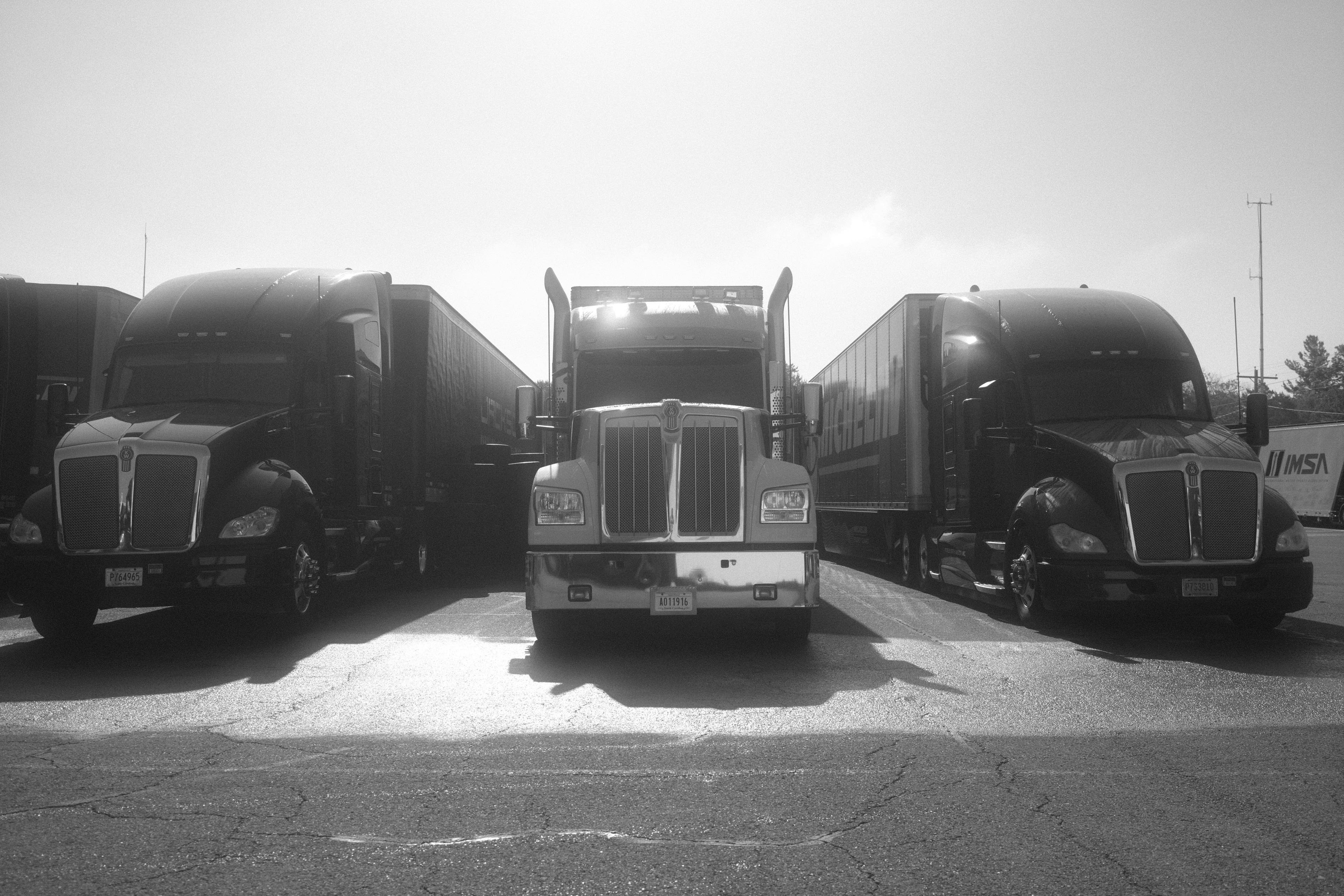Midday Standoff: A Trio of Trucks Anchoring the Lot