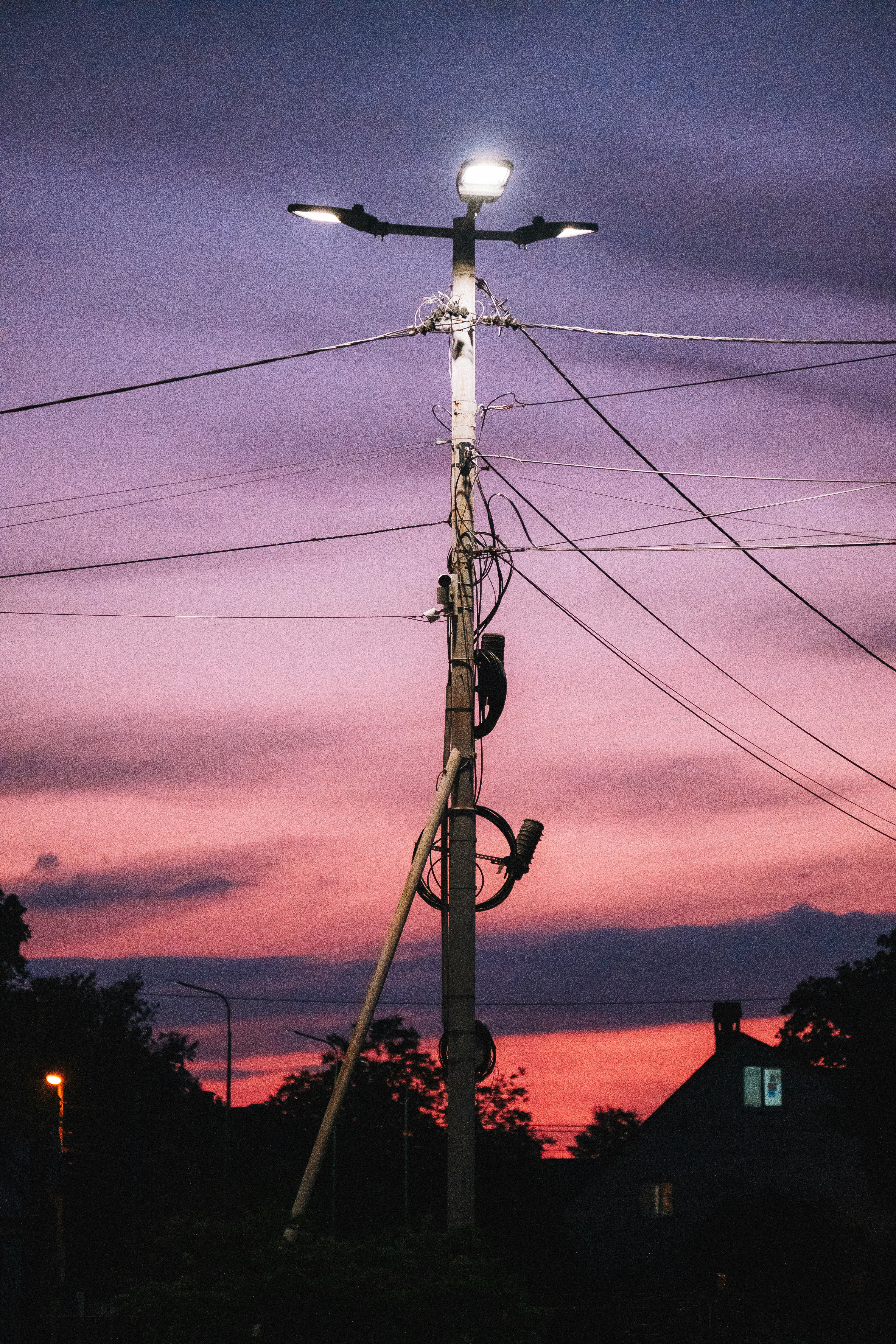 Pole of Light: Utility Tower Against a Sunset Gradient