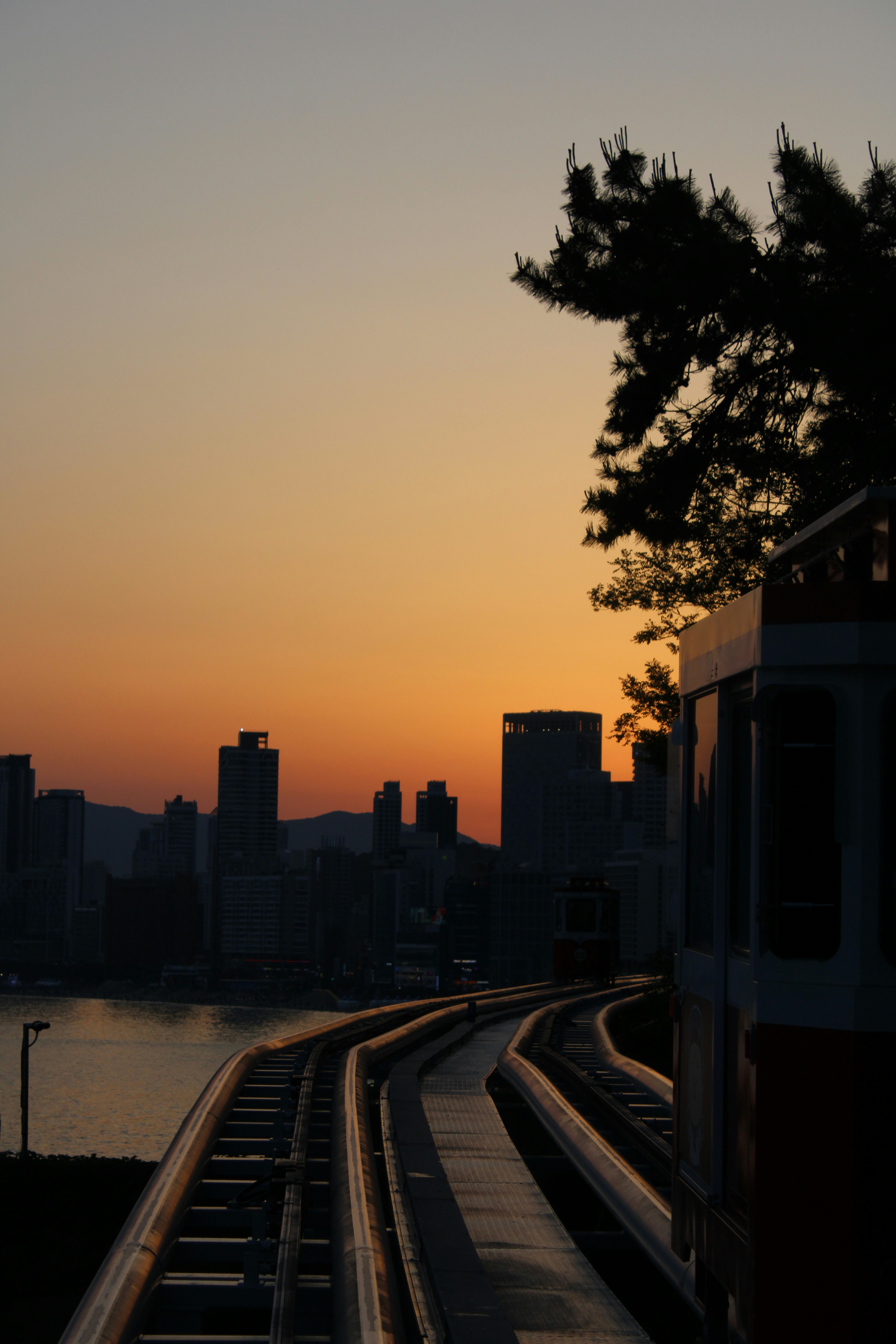 Sunset Skyline and Railfront: A Quiet City Evening at the Waterfront Tramway