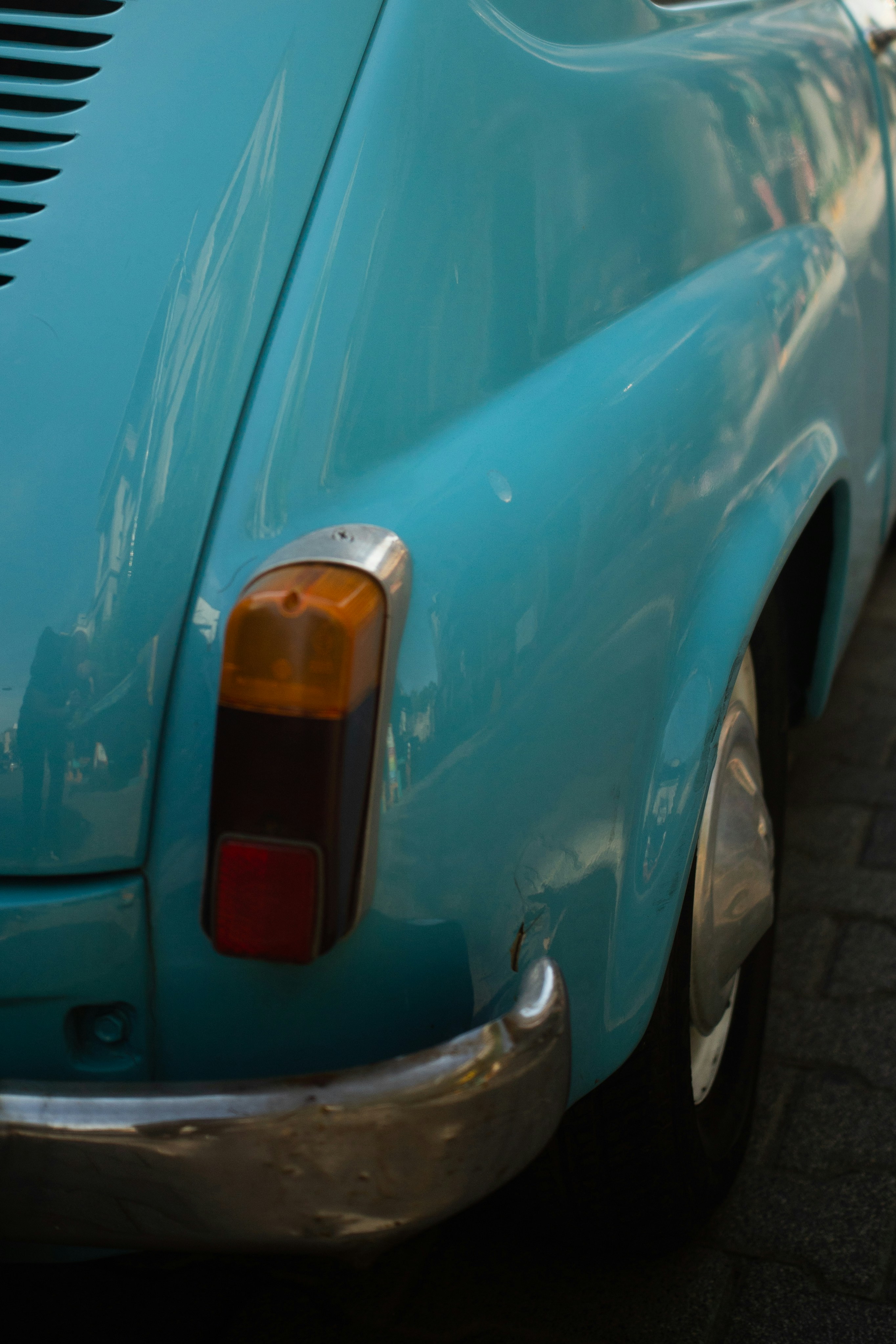 Aqua Vintage: Close-up of a teal retro car's rear quarter and taillight