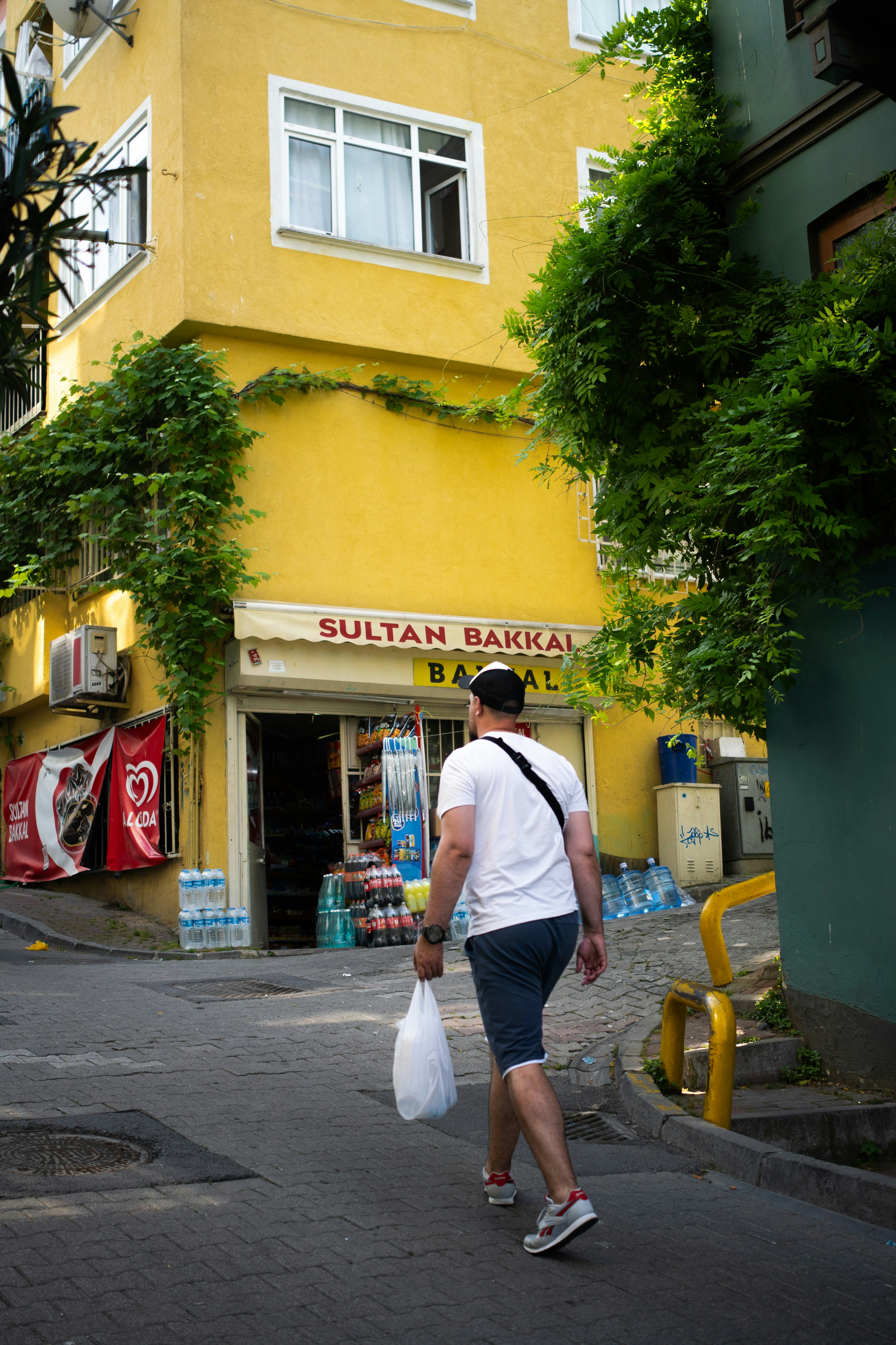 Street Shopper in Front of a Yellow Market Facade