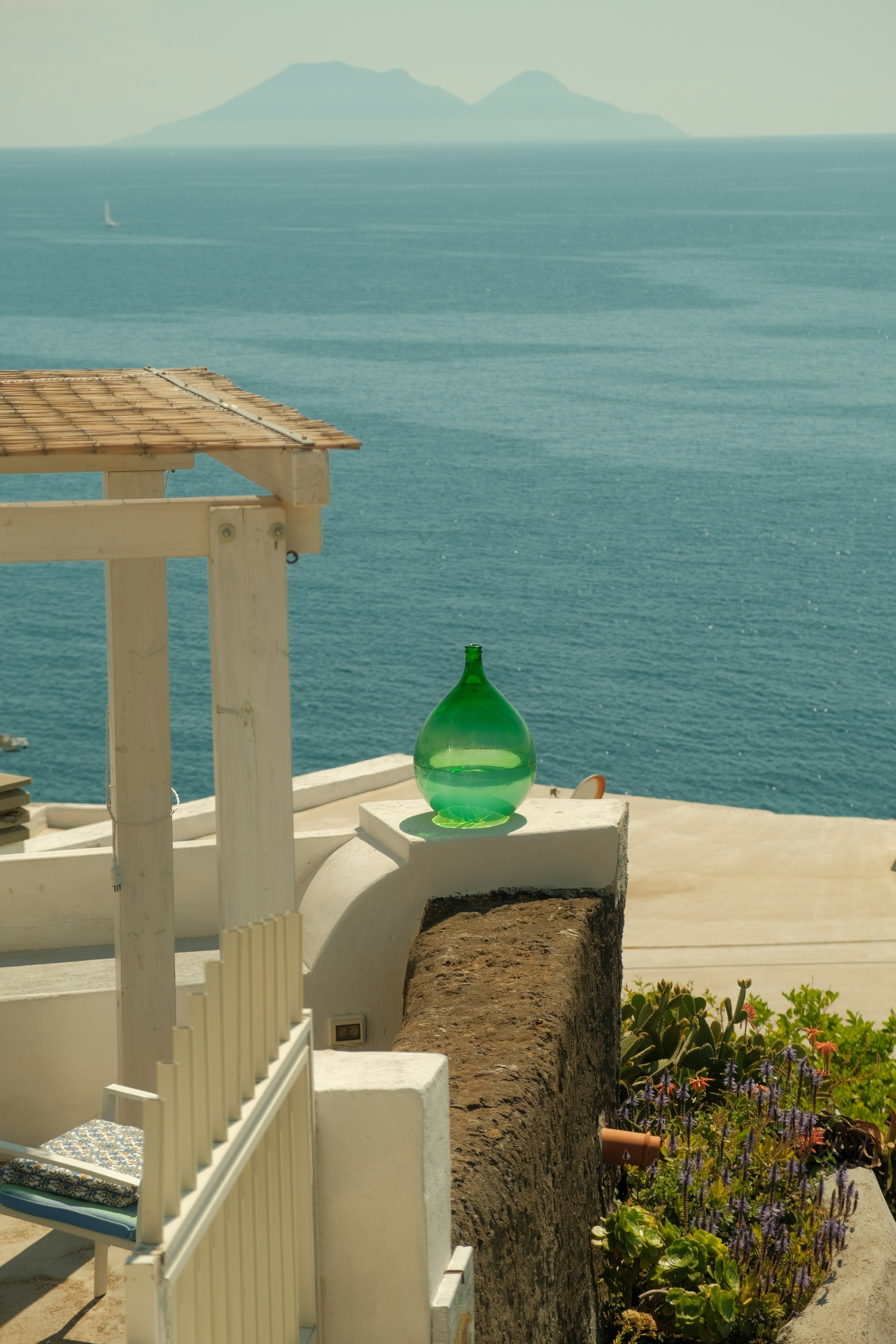 Green Glass Vase and Mediterranean Terrace Overlooking the Sea