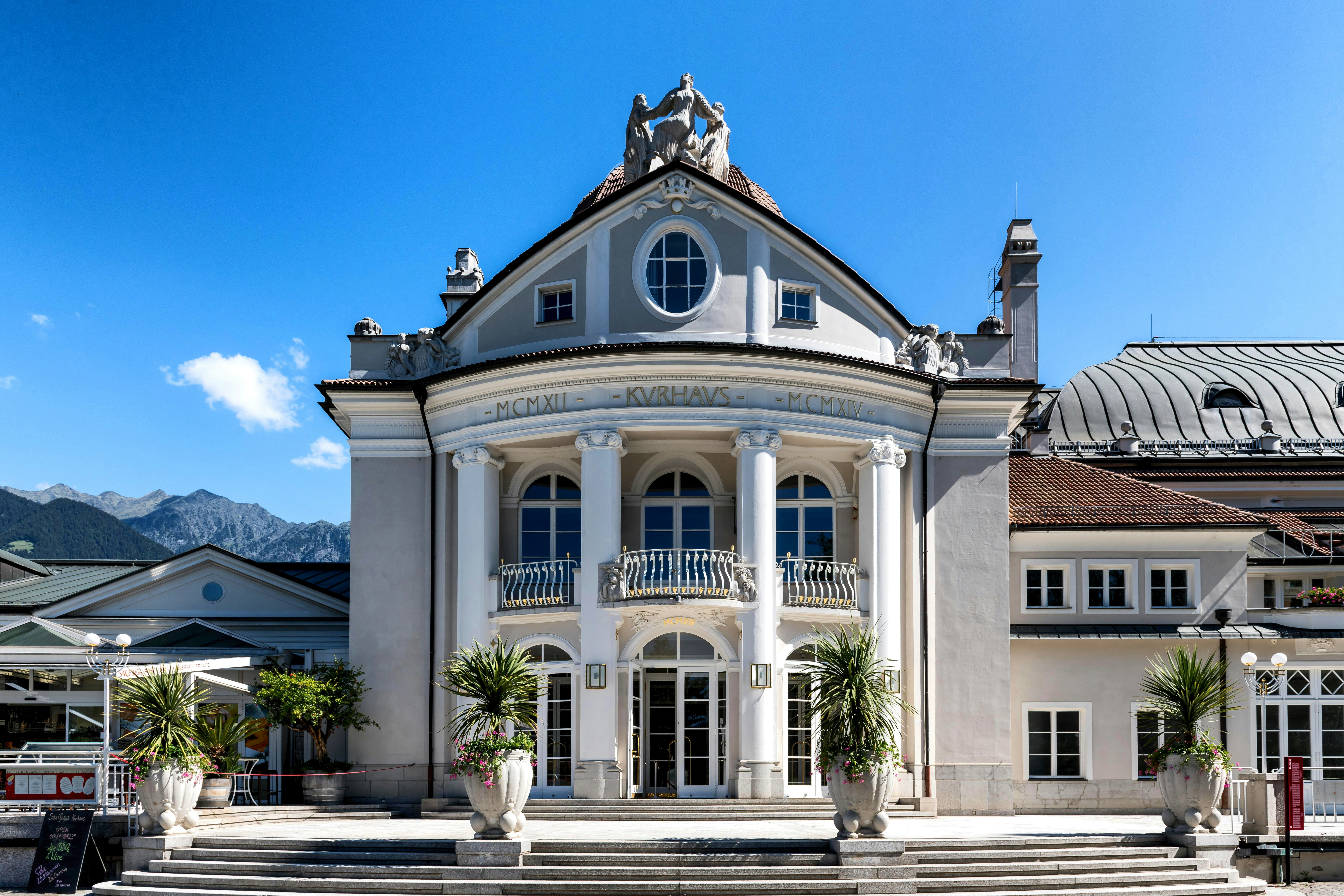 Grand Alpine Facade: Symmetry, Columns, and Crest Above the Steps