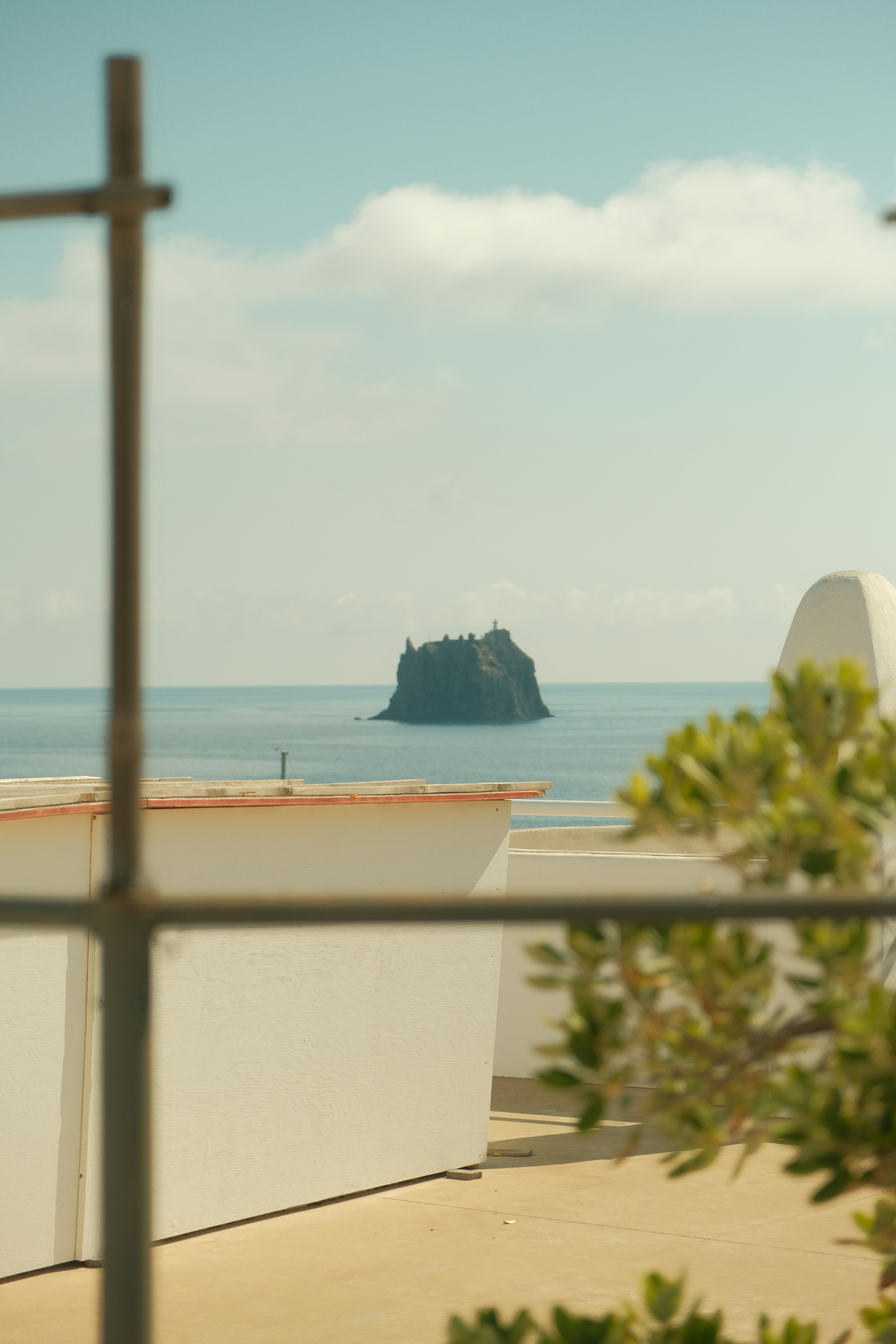 Sea Stack in Calm Vista Framed by Balcony Shadows