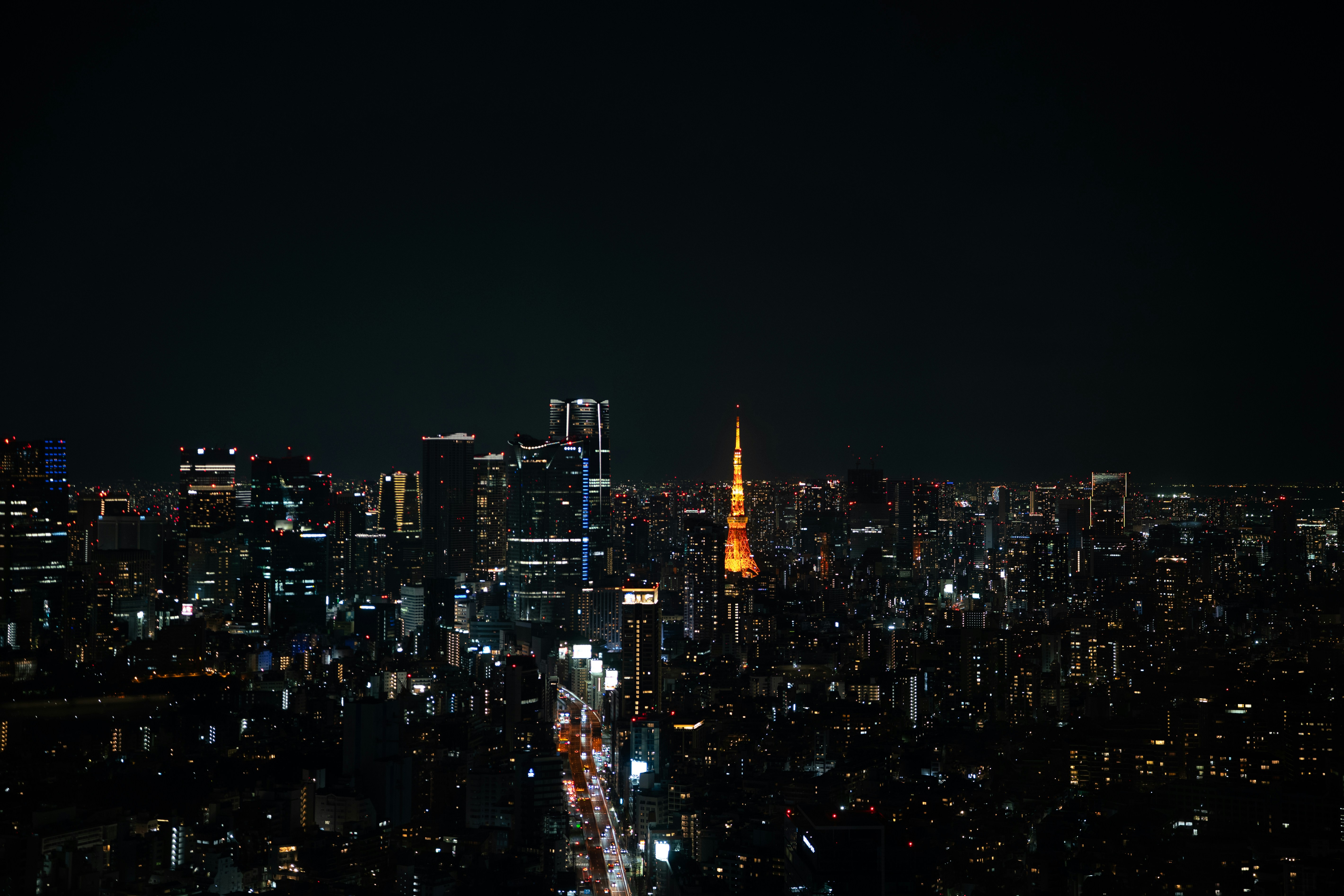 A vibrant cityscape at night with the illuminated tokyo tower.