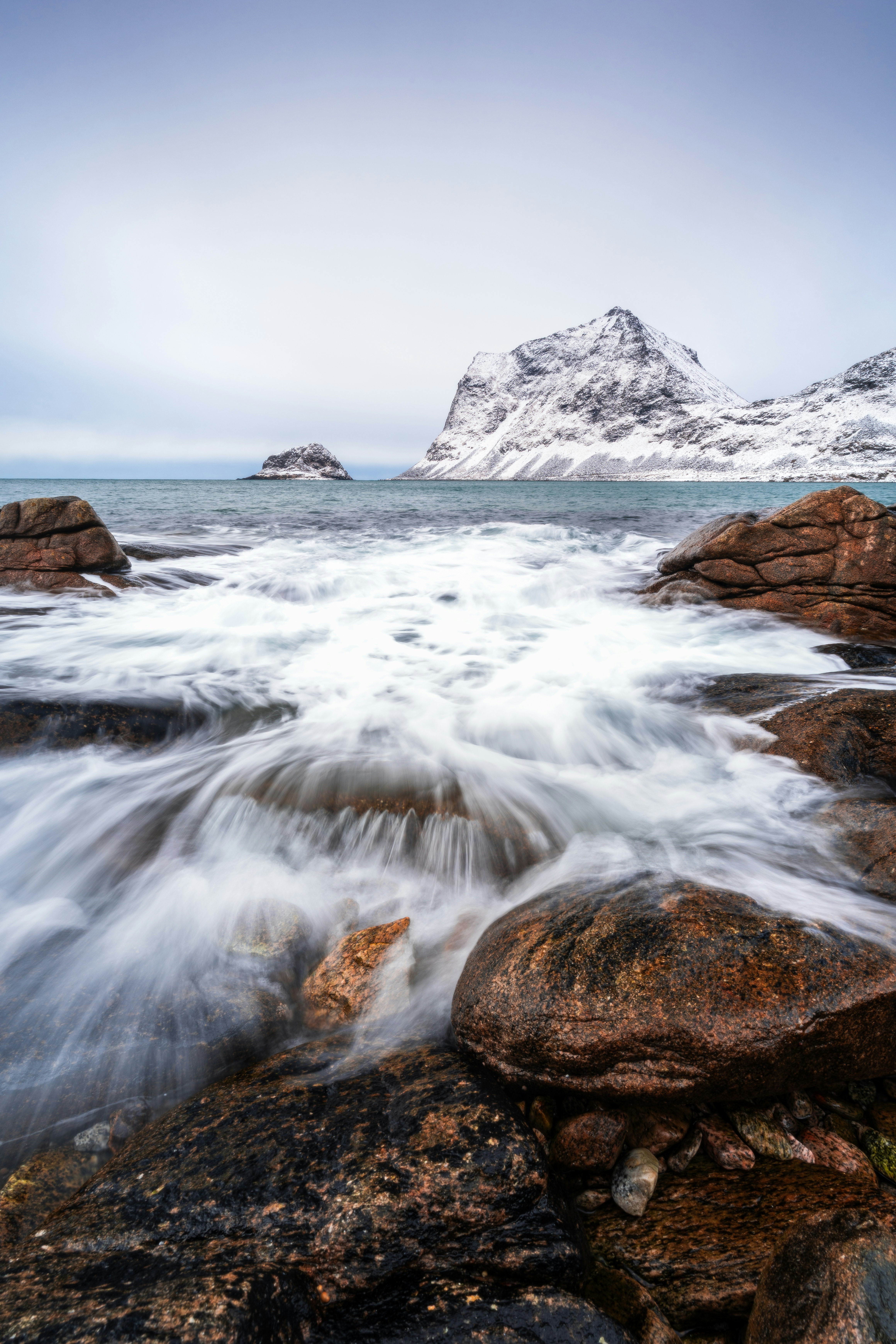 Icy Coastline Crowned by a Snowy Peak