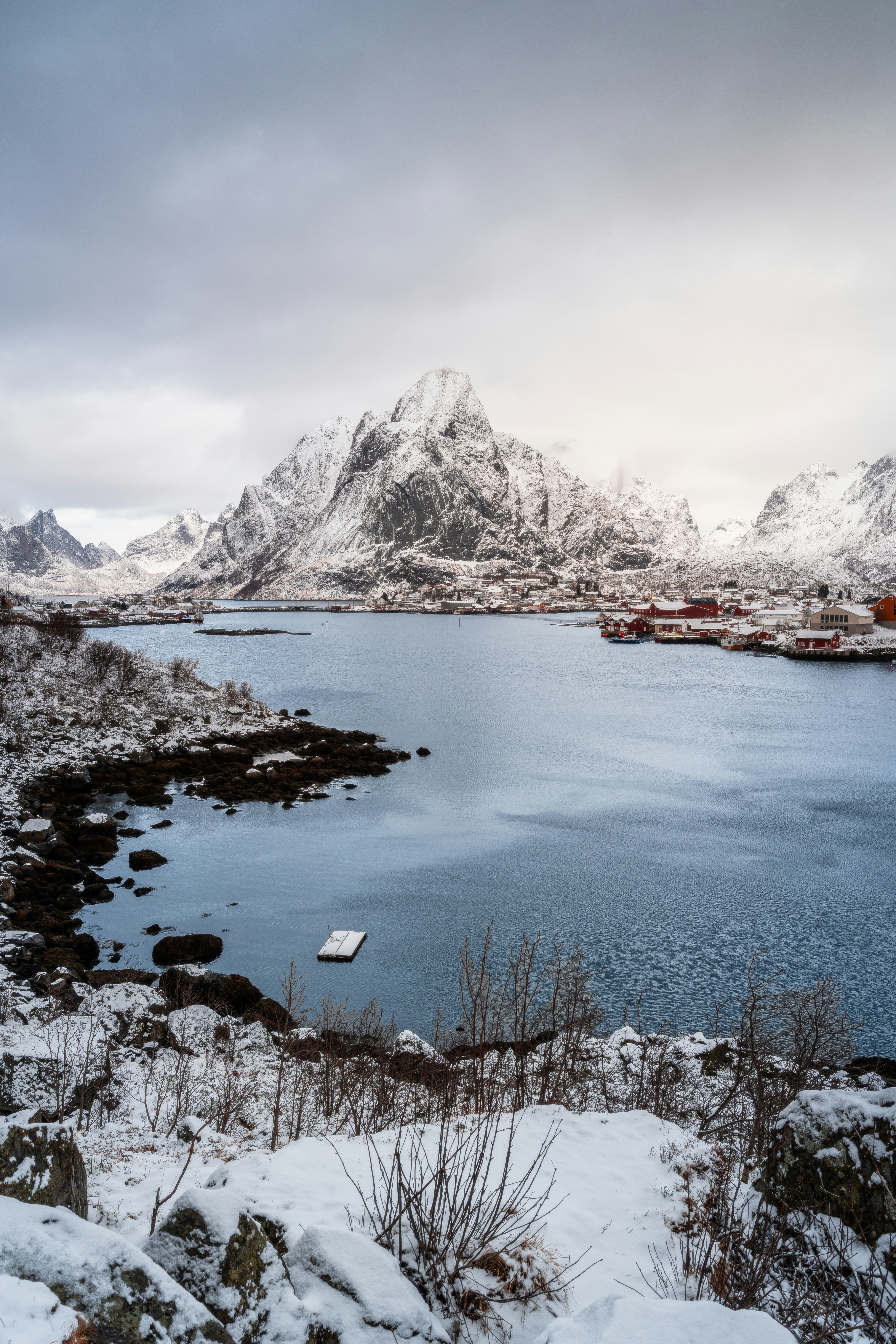 Snow-kissed Peaks Over a Quiet Nordic Harbor