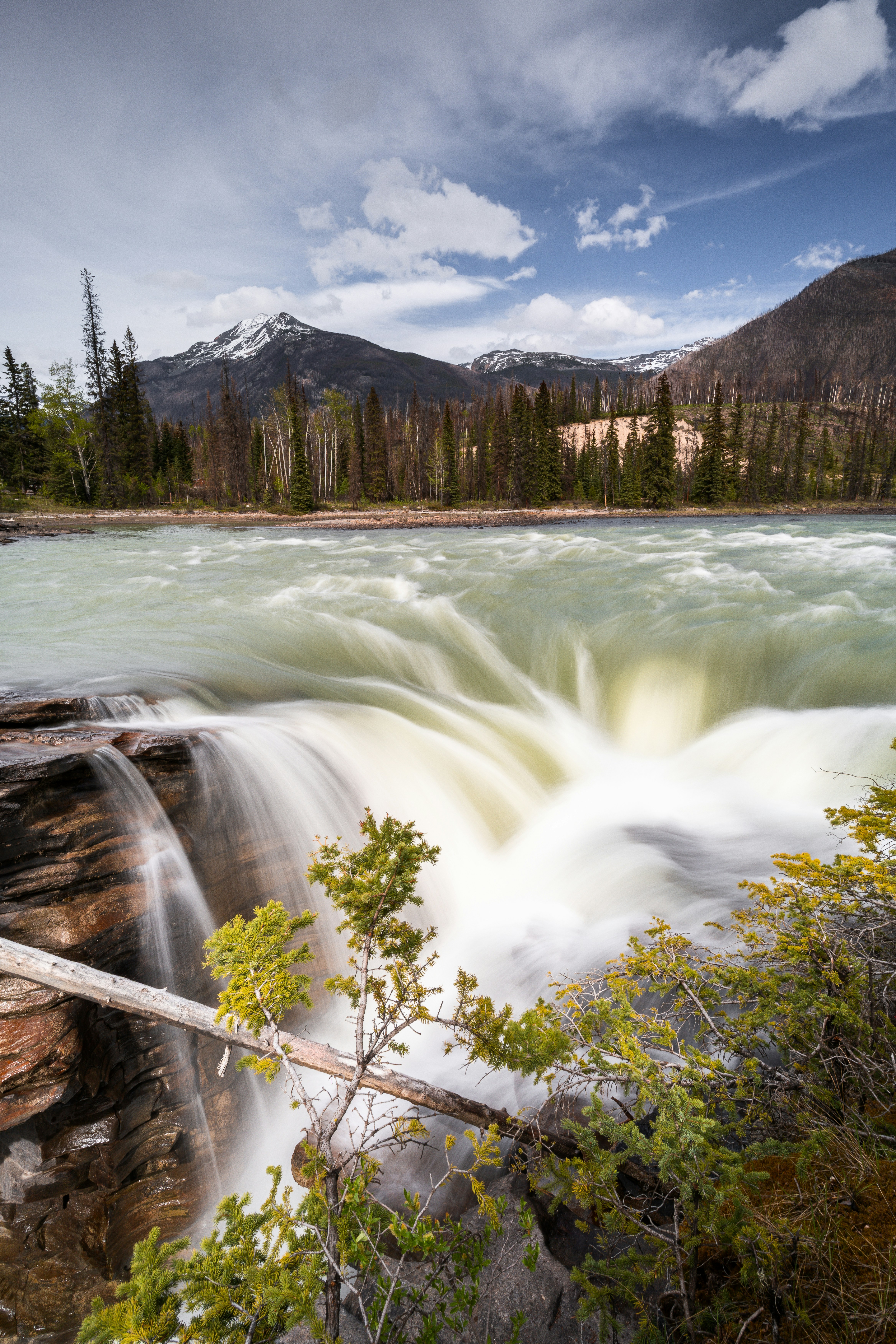 Rushing Edge: Alpine Cascade Beneath a Snowy Range