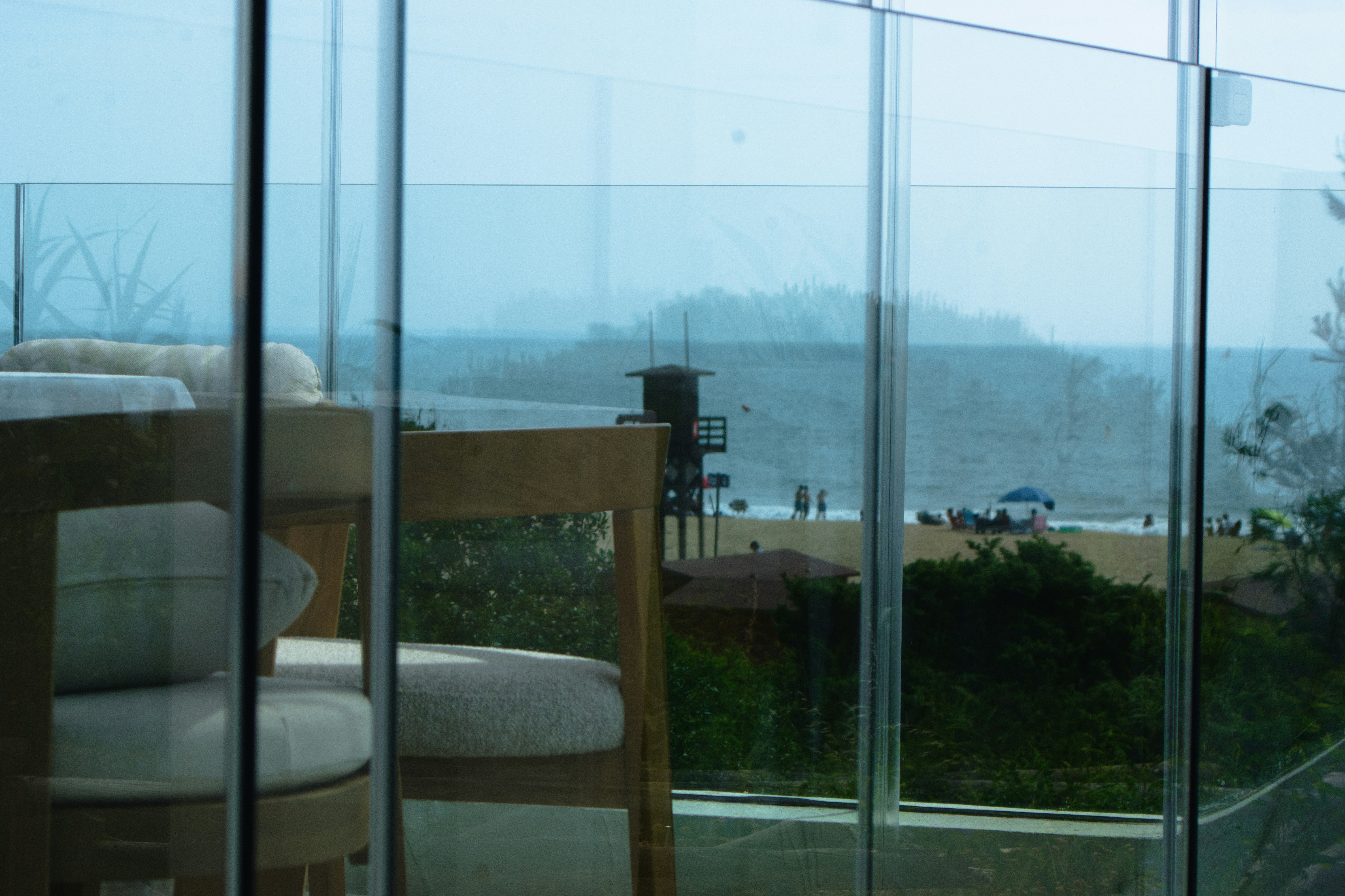 Beachfront Scene through a Glass Corridor