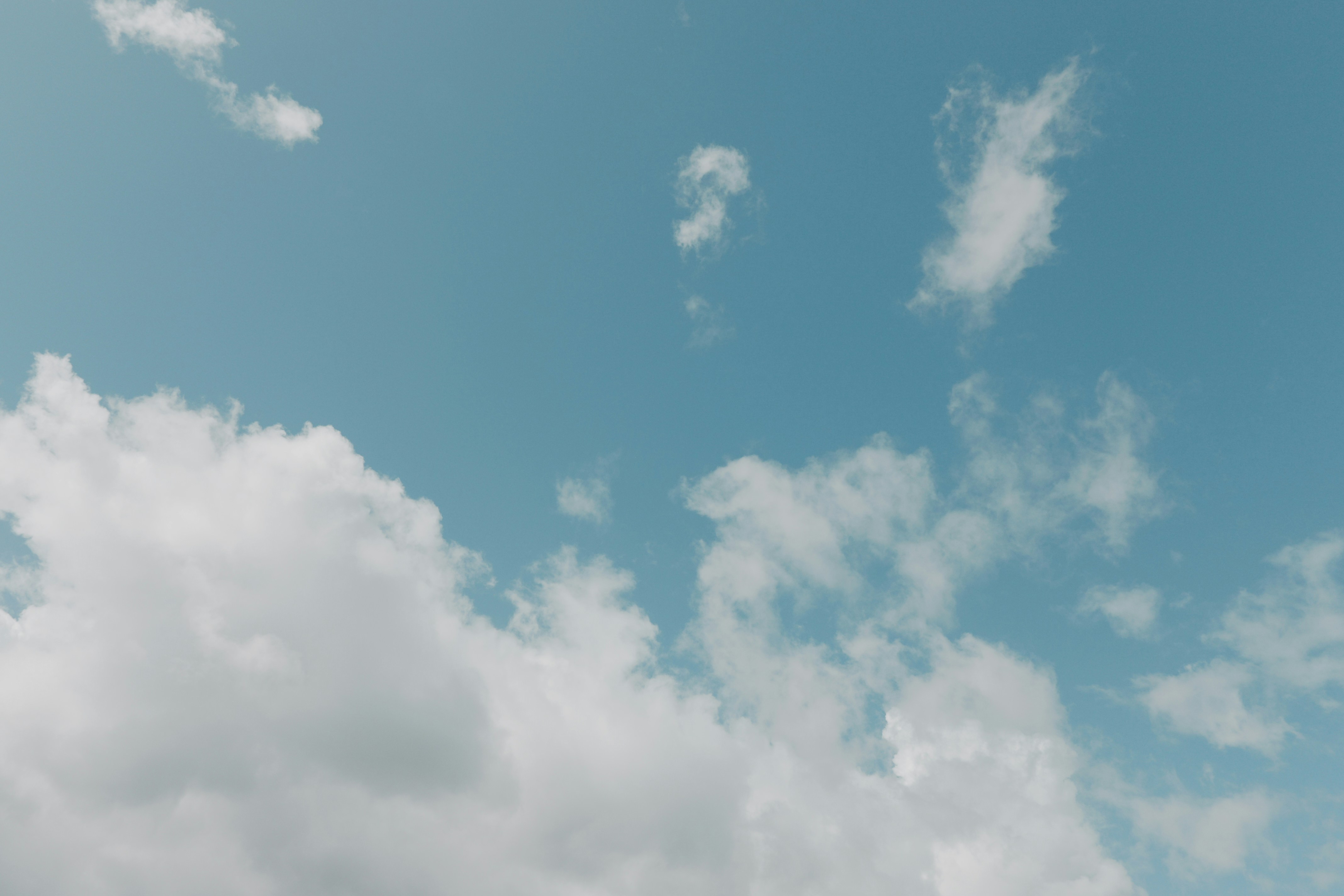 Skyward Whispers: A Gentle Cloudscape Under Open Blue