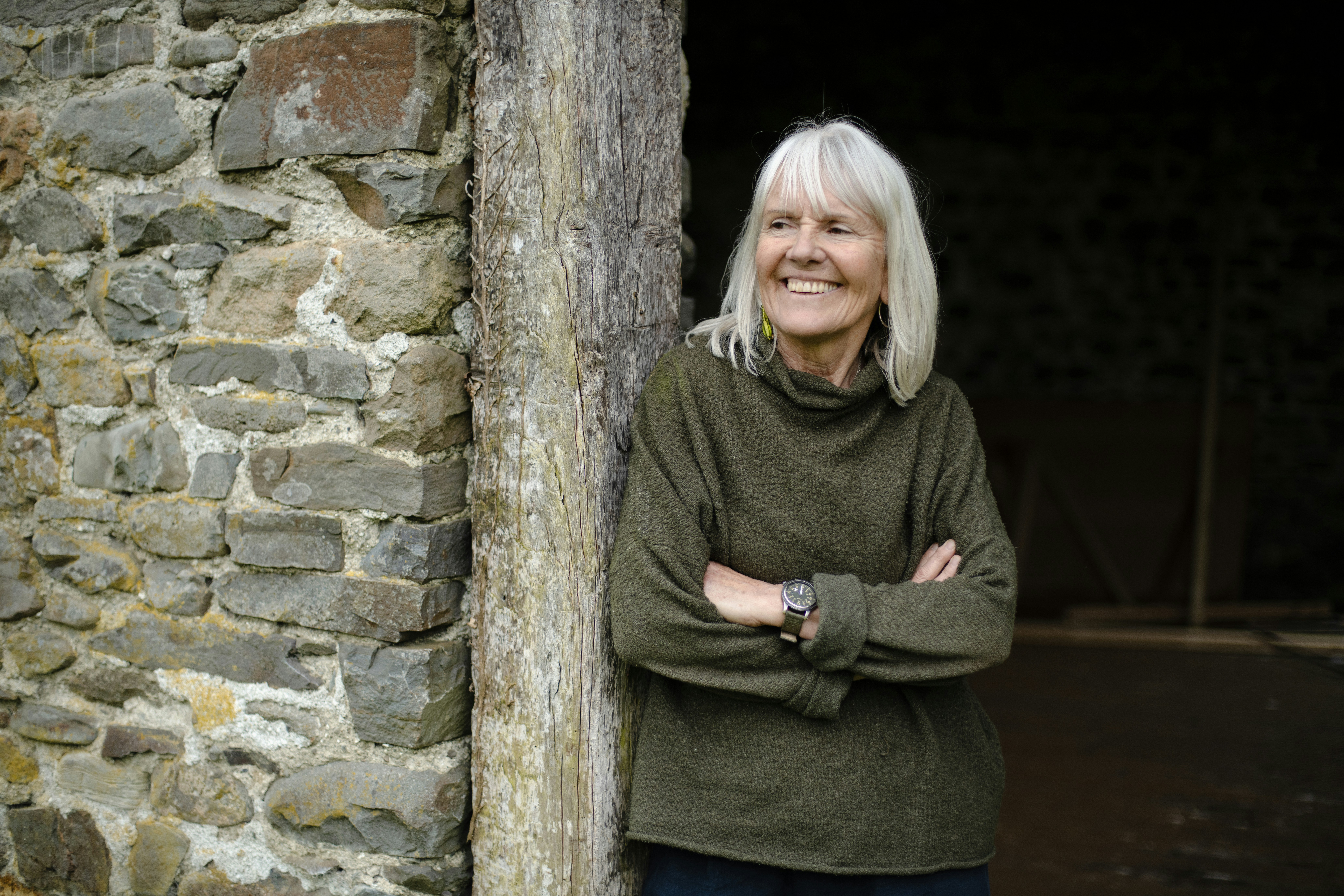 Sunlit Confidence: A Portrait by the Old Stone Wall
