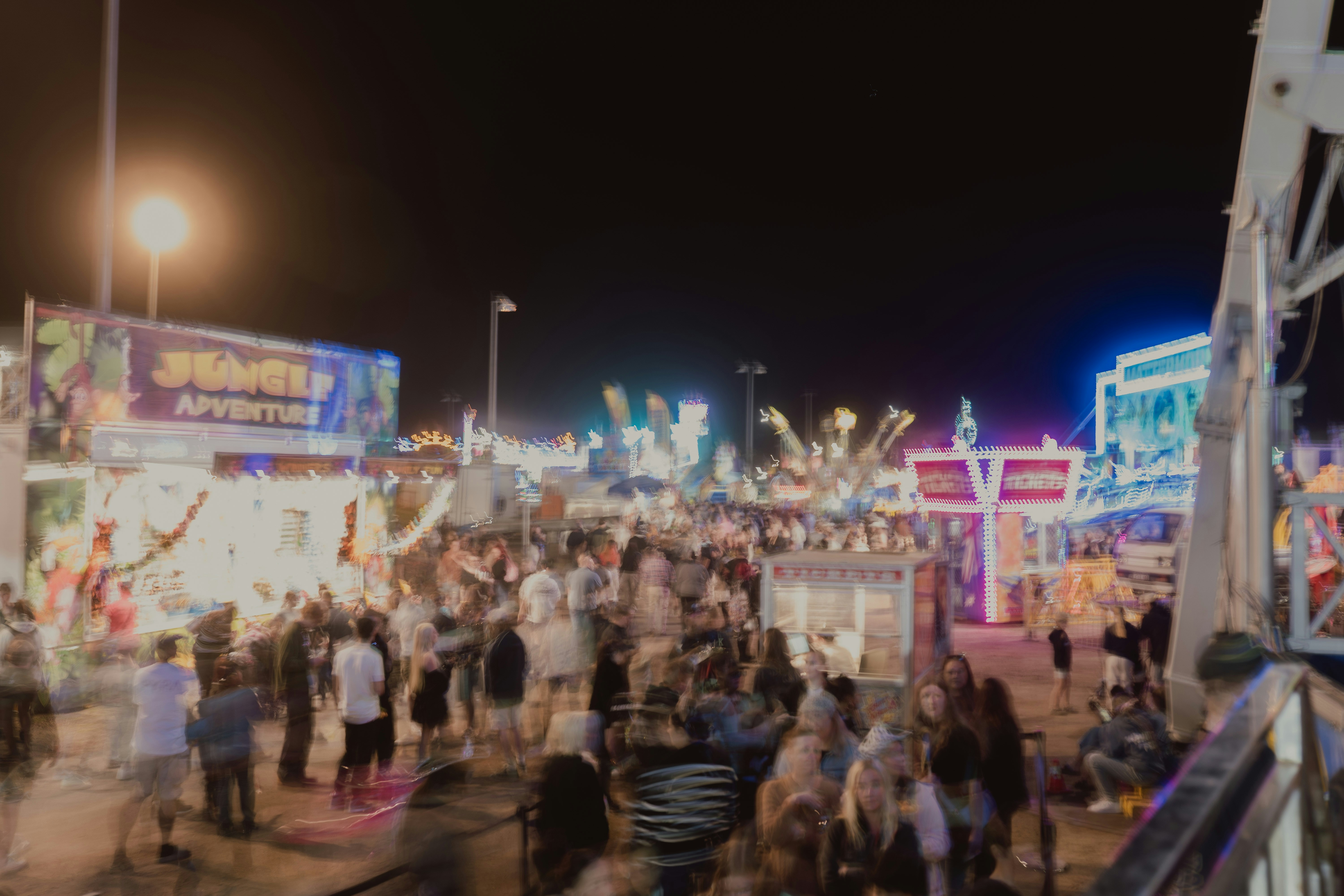 Night Carnival Pulse: Blurred Lights and Moving Crowd