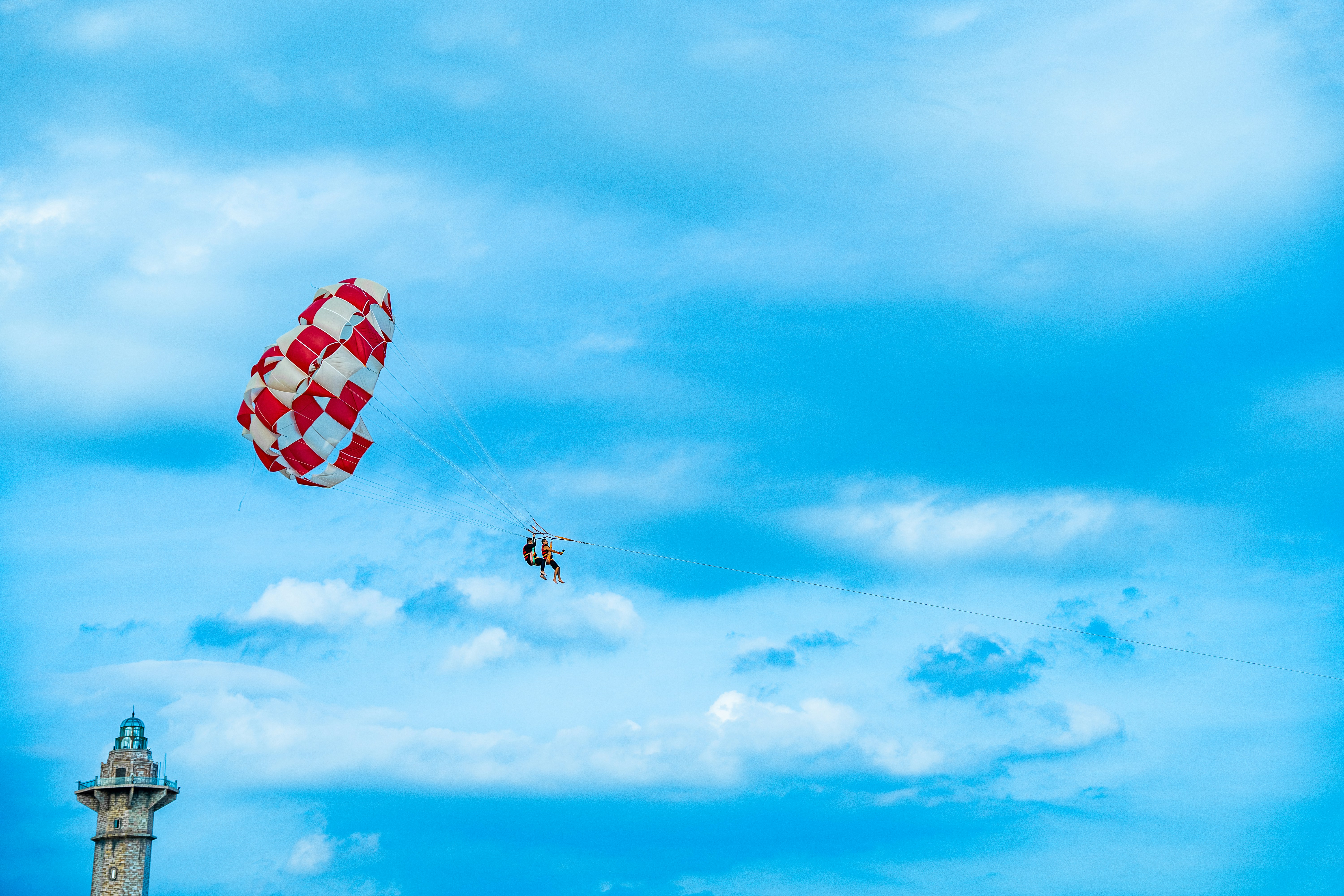 Skyward Glide: A Parachute Descent Over the Harbor Spire