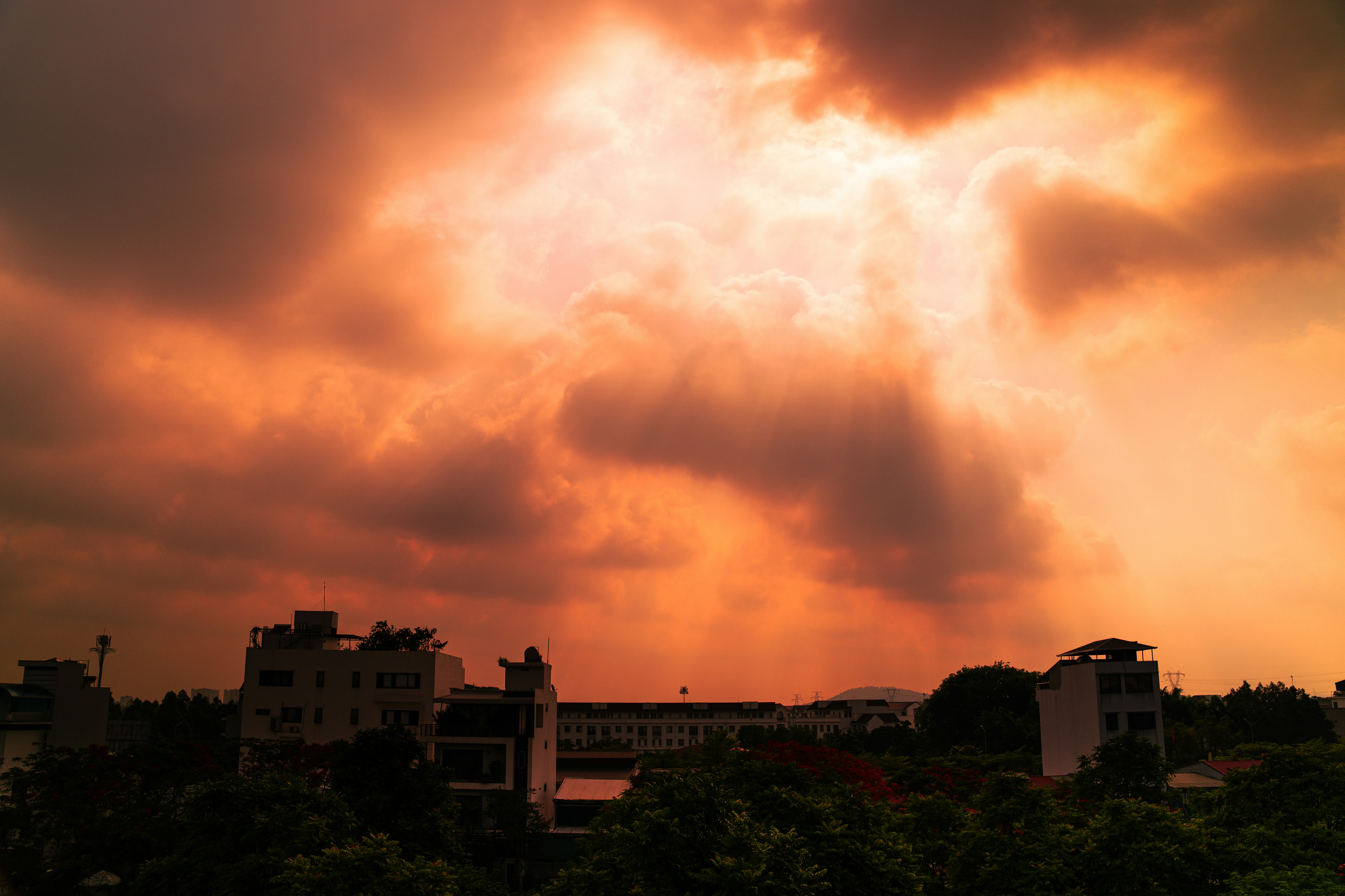 Sunset Breakthrough: Rays Over Quiet Rooftops