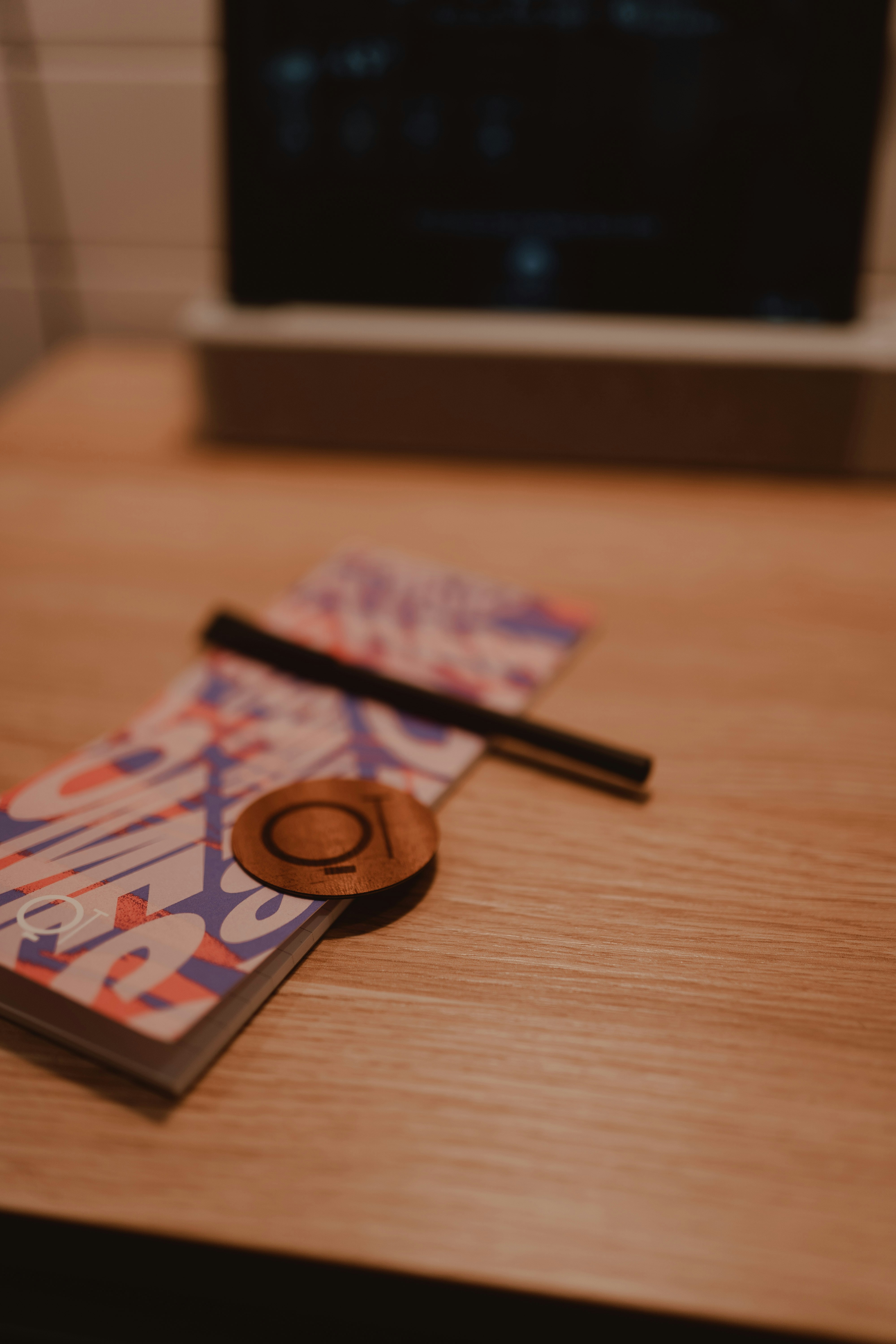 Stacked Cards and a Wooden Token on a Warm Kitchen Counter