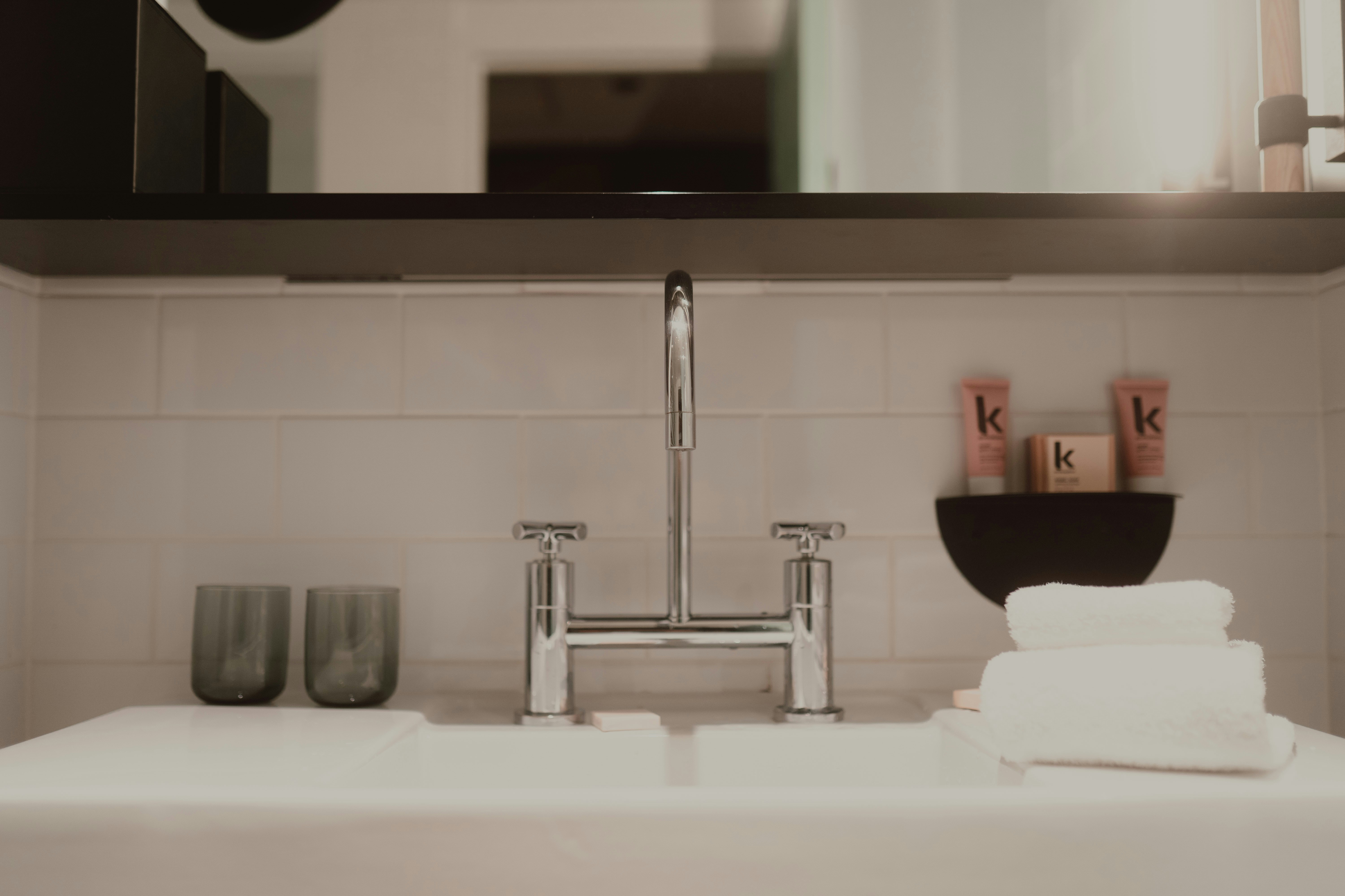 Minimalist Bathroom Sink with Chrome Faucet under Soft Backlit Mirror