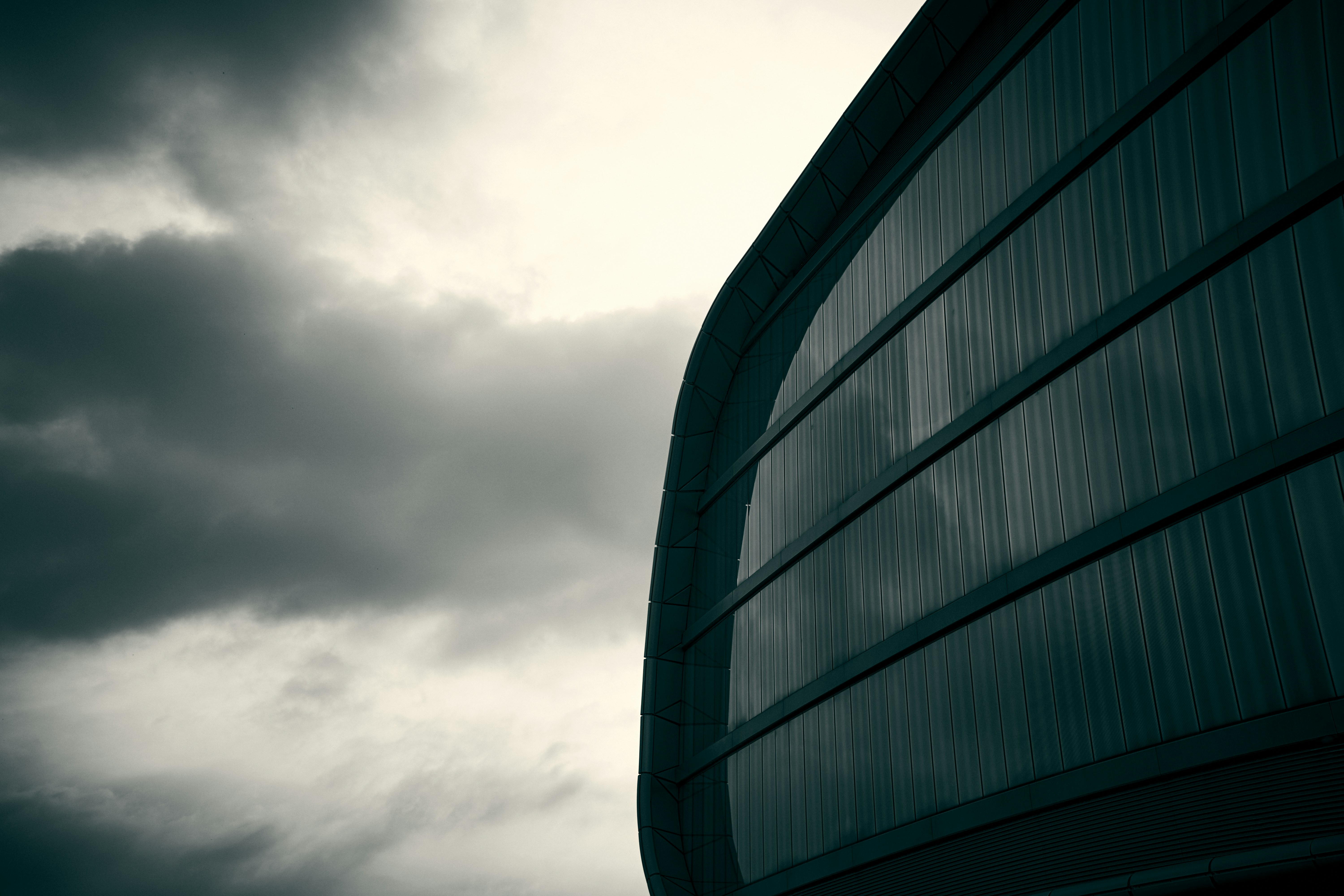 Edge of the Glass Curve under a moody sky