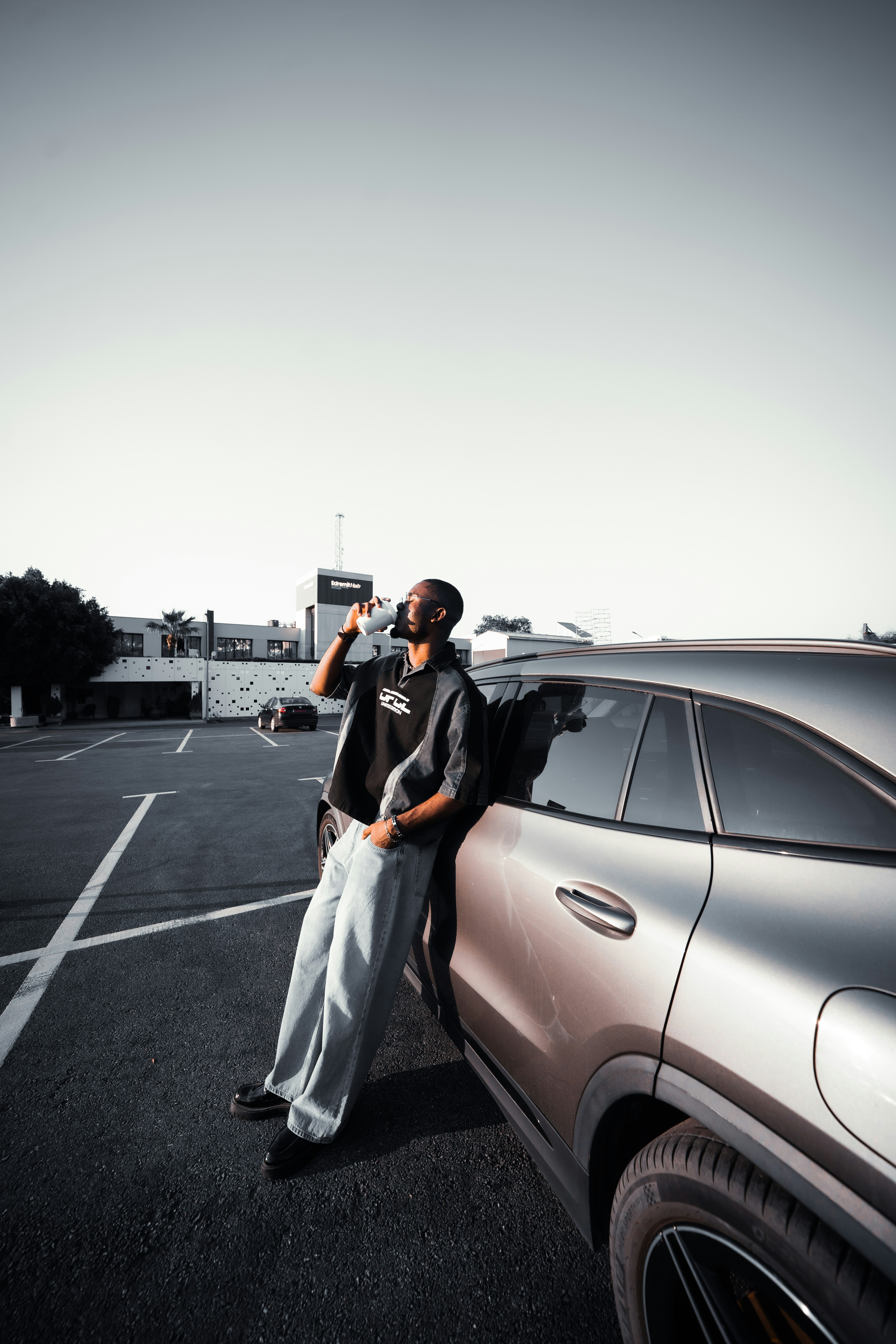 Casual Confident: A Stranger’s Moment by the Car in the Lot