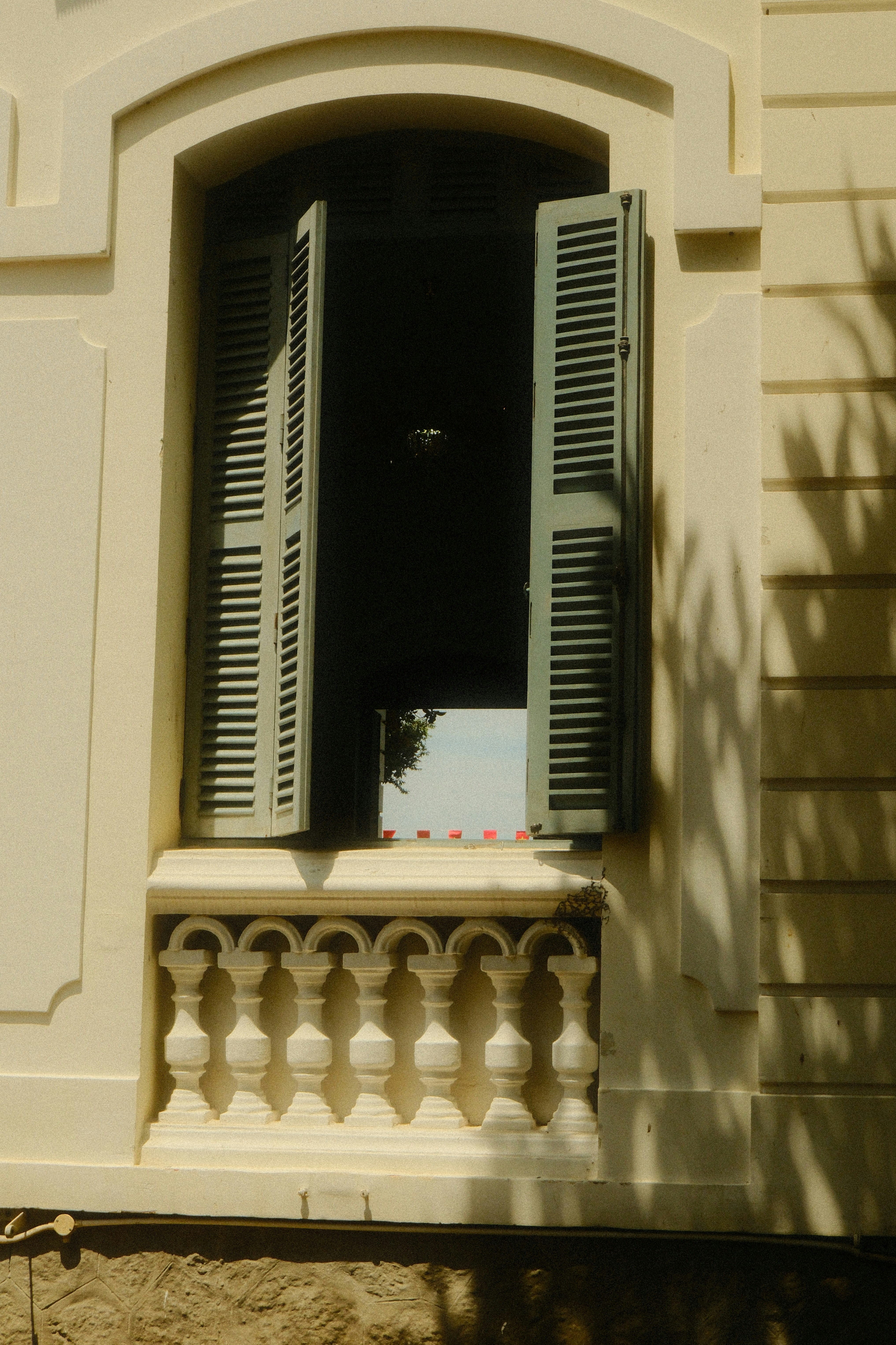 Open Window to Light: A Sunlit Archway with Shuttered Frame