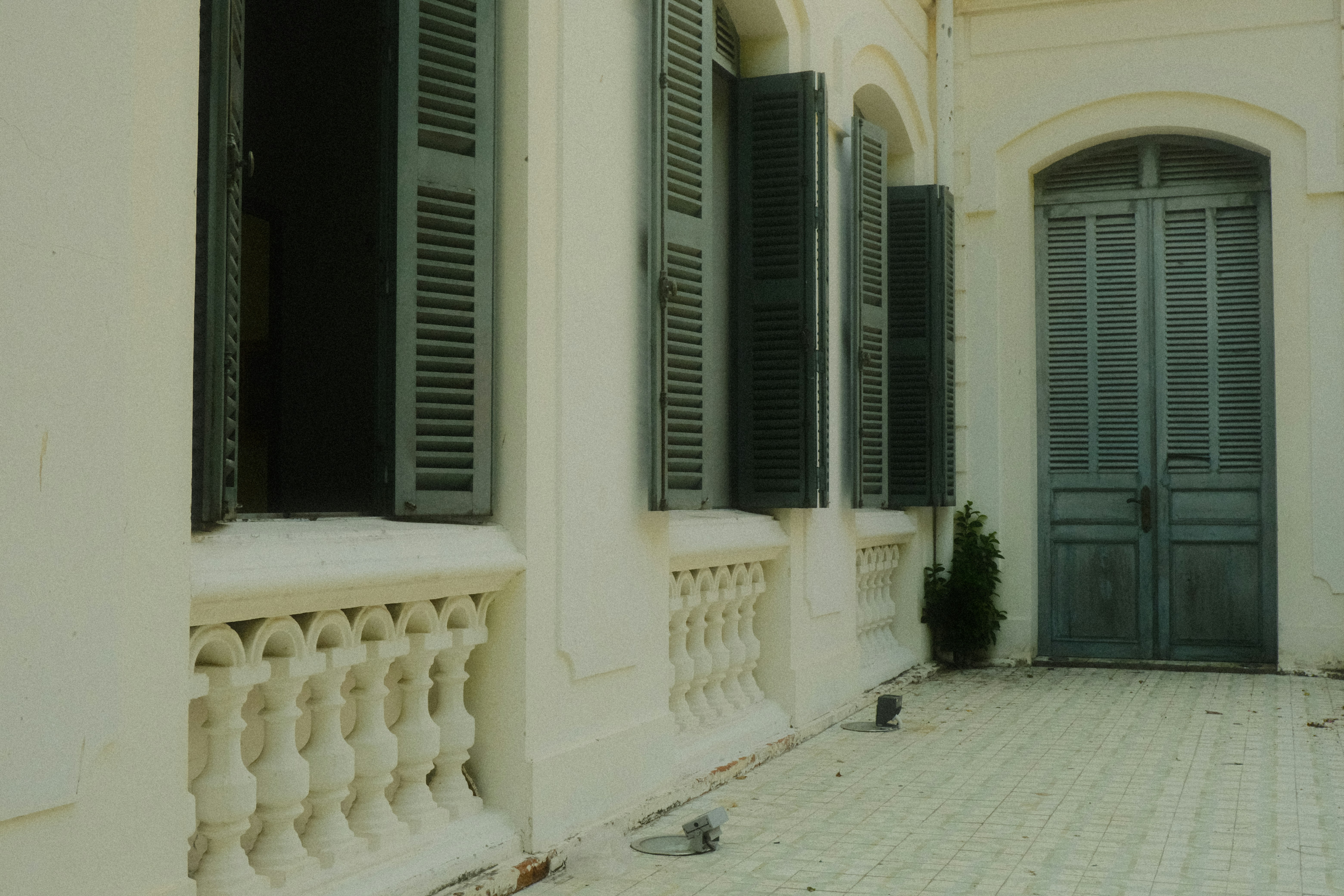 Quiet Courtyard Facade: Deserted Corridor with Shuttered Arches