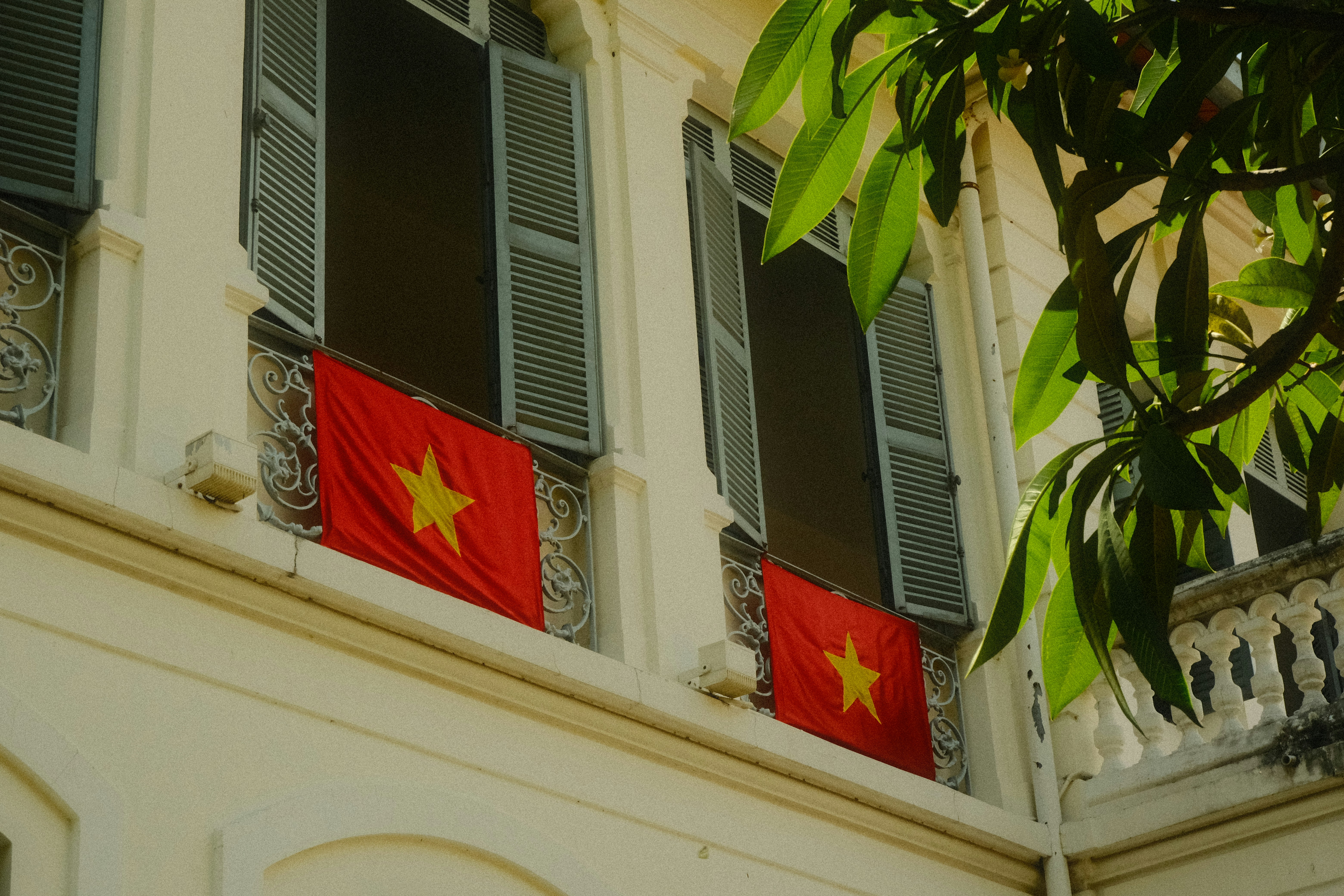 Sunlit Flags on a Classic Balcony