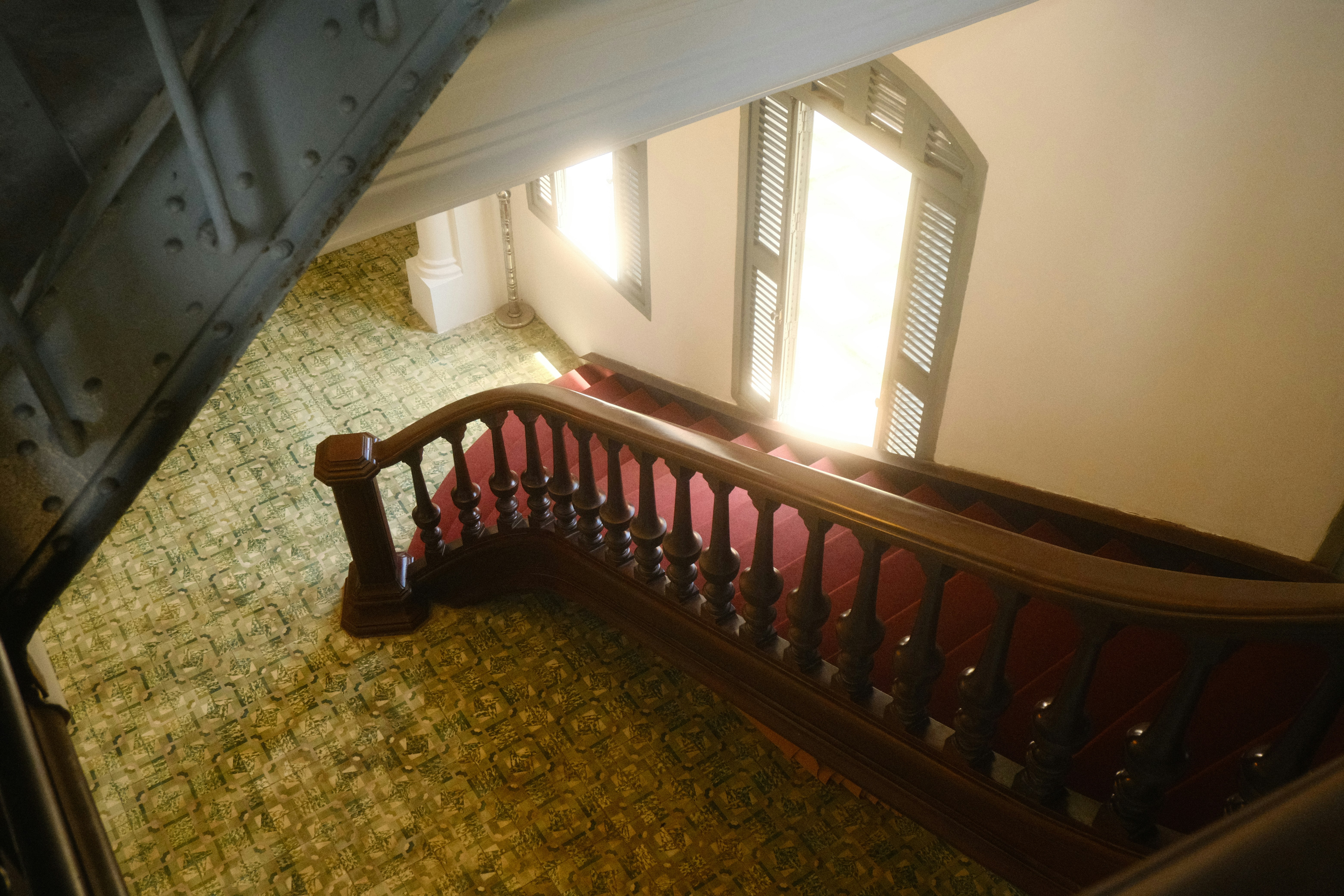 Descending light: The antique staircase bathed in sunlit amber