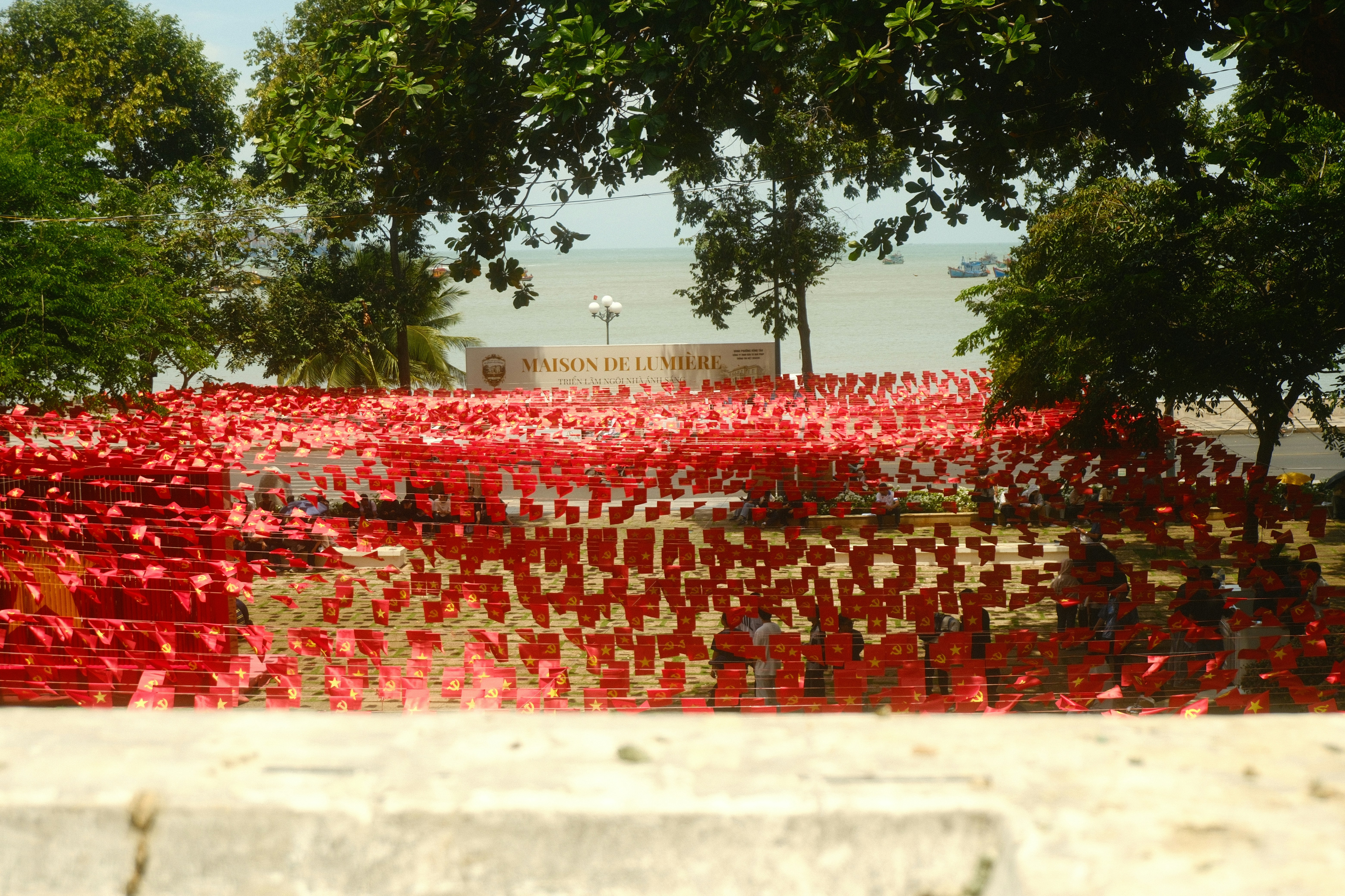 Terraced Sea of Red: An Overhead View of Ribboned Seats by the Shore