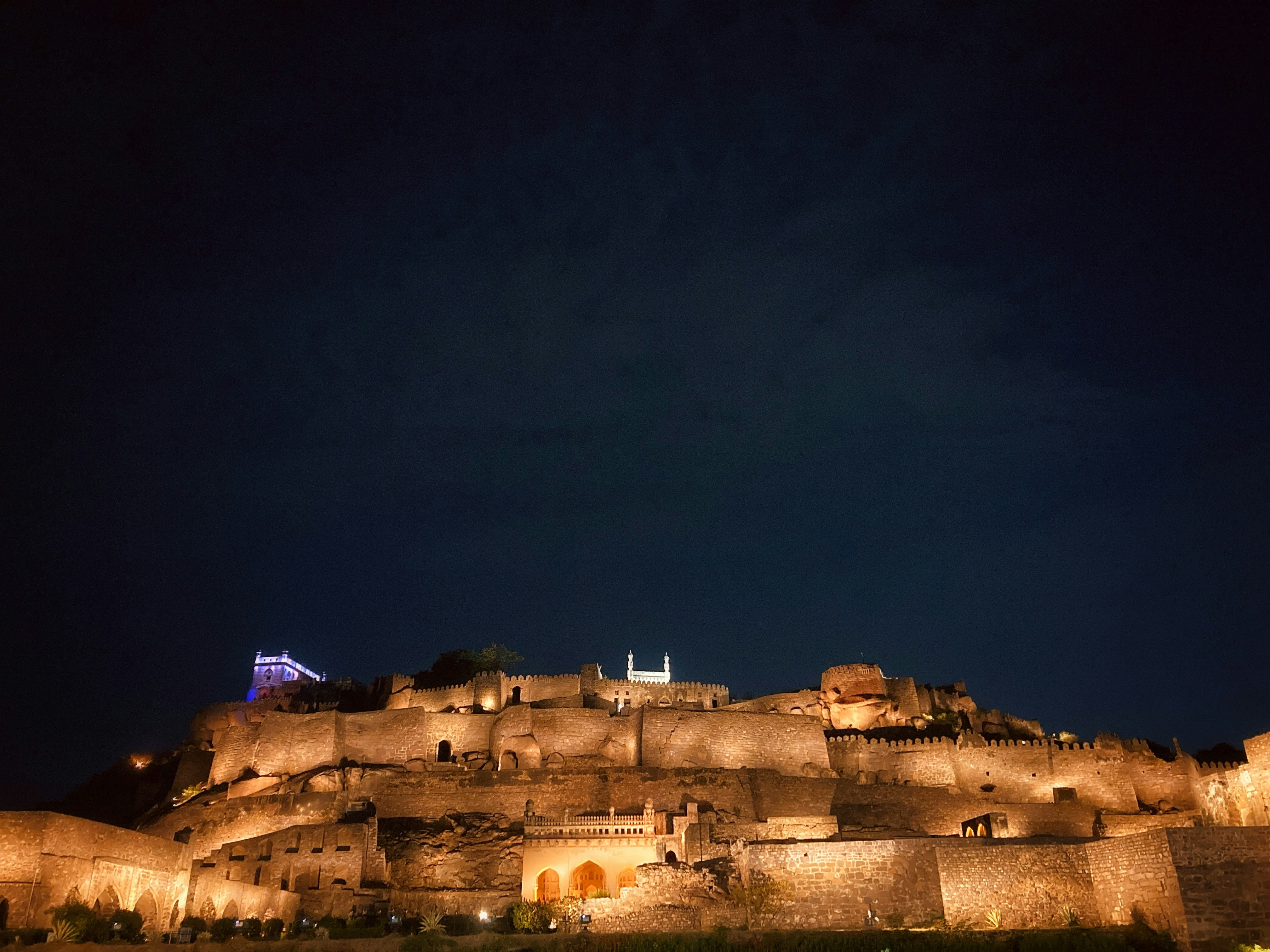 Moonlit Citadel: Gold Walls Loom Over the Night