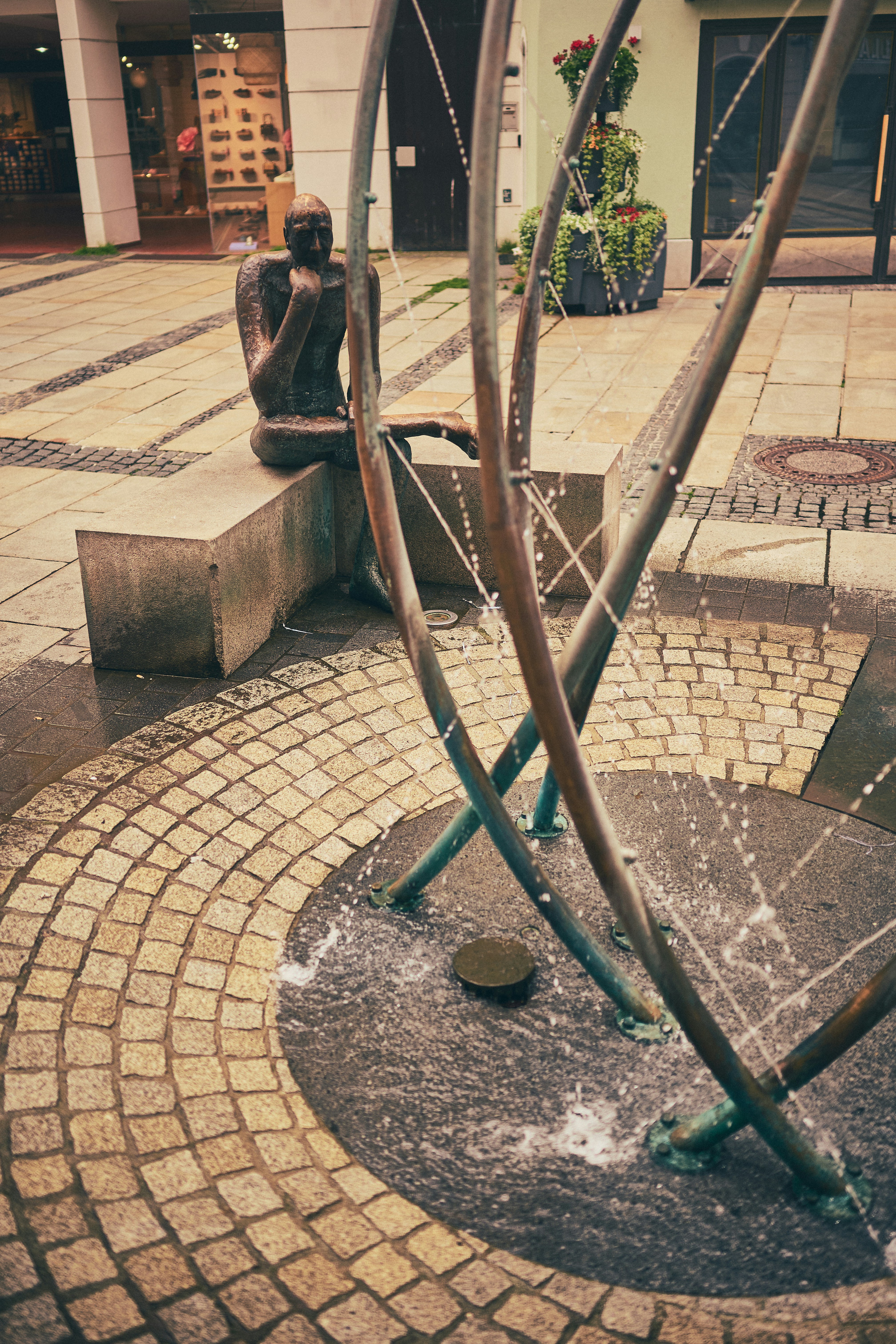 Contemplation by the Fountain: Abstract Spheres and a Quiet Figure