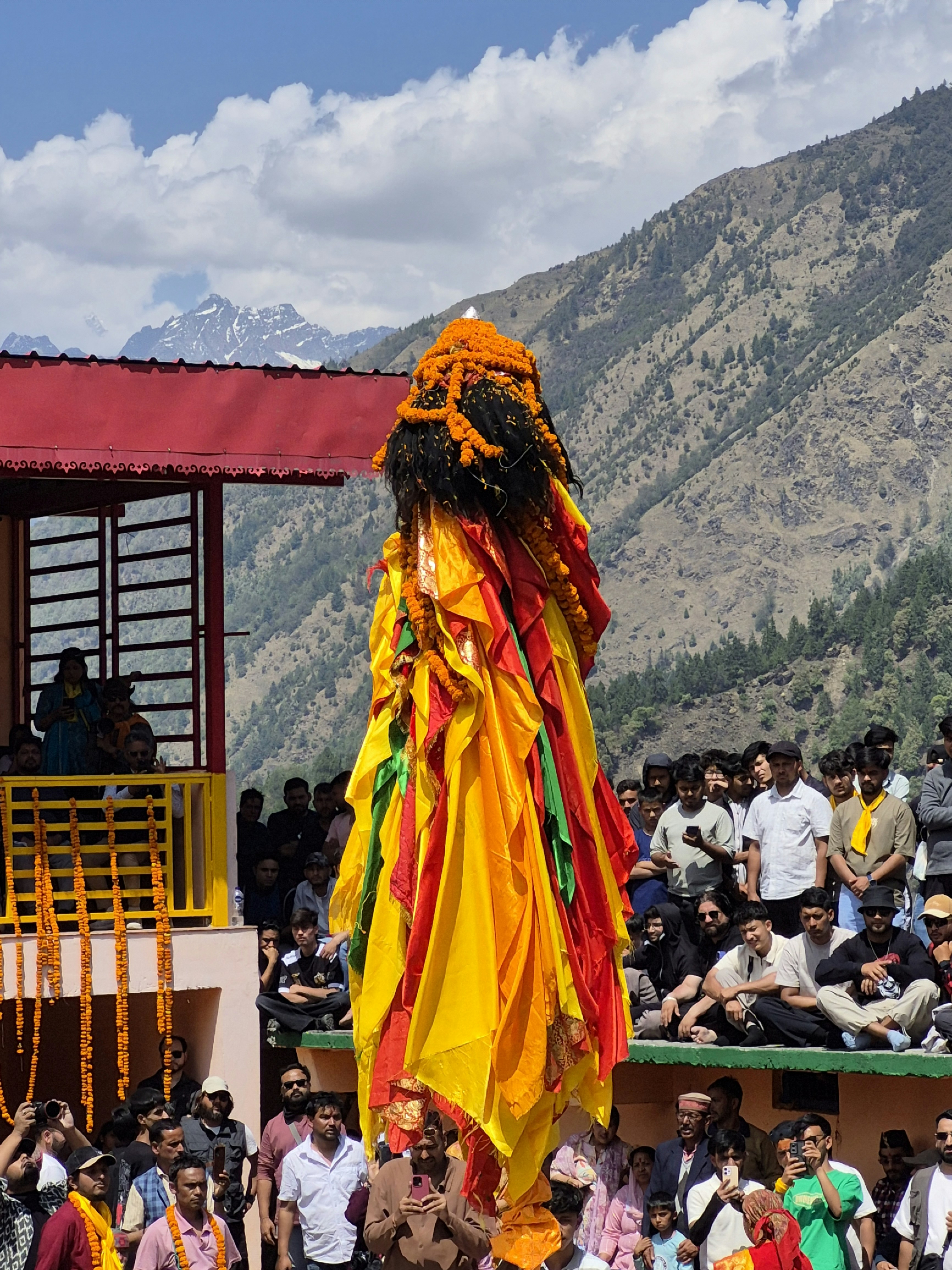 Colors of Ceremony: The Tall Figure in Bright Ribbons