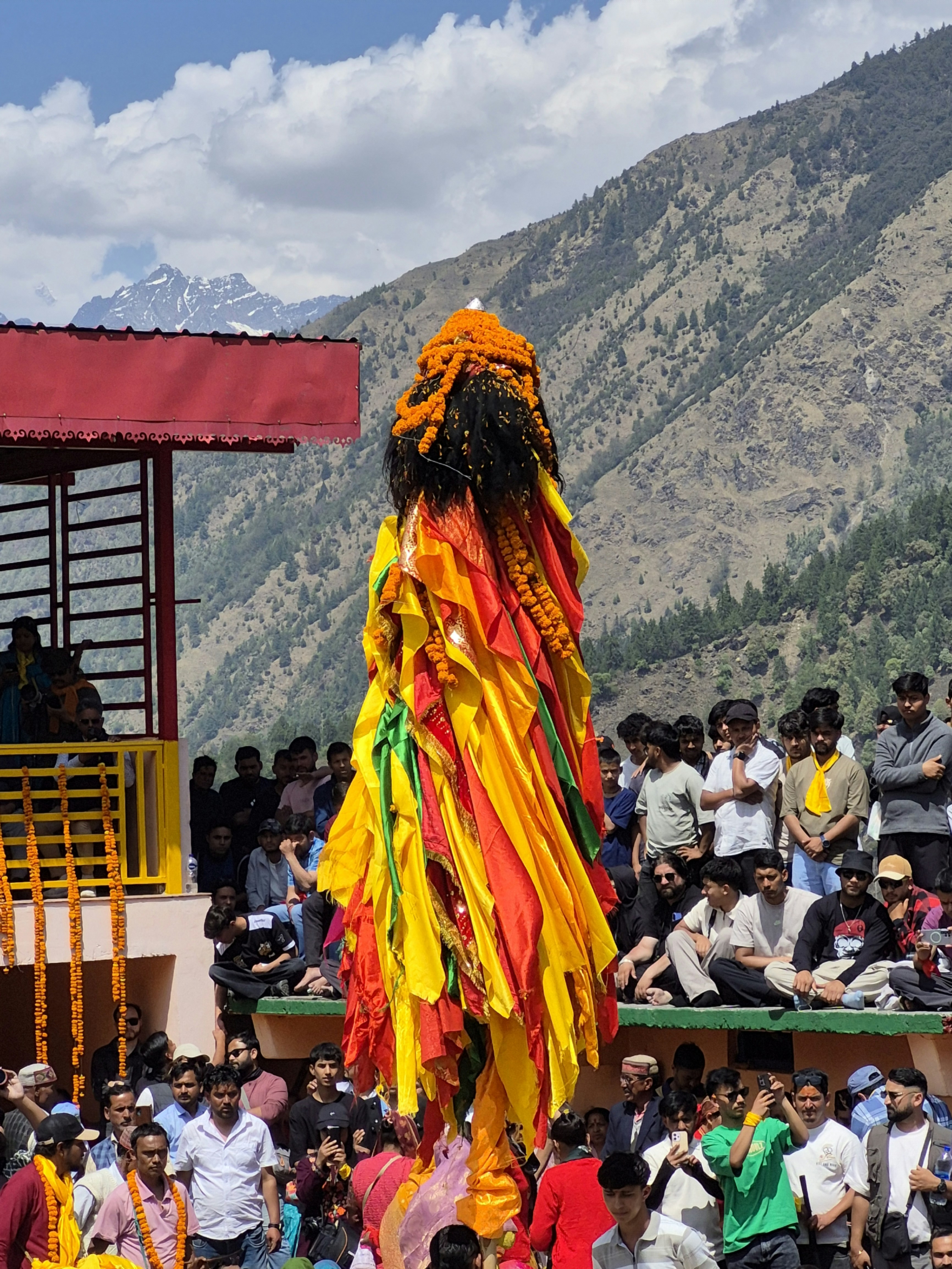 A divine moment captured during the ancient Ramman Festival in Chamoli, Uttarakhand, India. The image features the sacred dance of Bhumiyal Devta (the guardian deity of the village). Ramman is recognized by UNESCO as an Intangible Cultural Heritage of Humanity, celebrated with ritual theater, music, and traditional masked dances against the backdrop of the majestic Himalayan mountains.