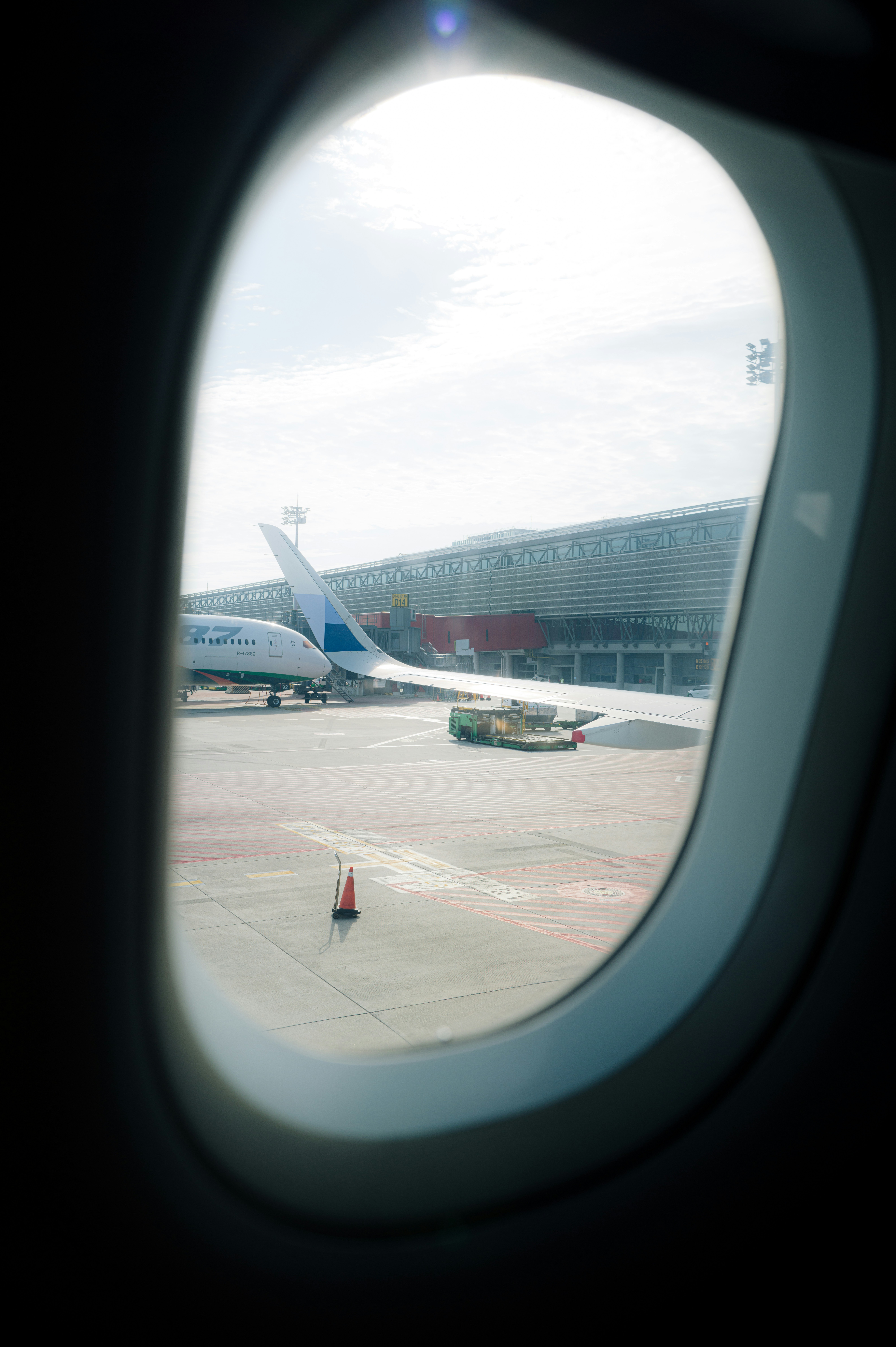 Window Frame View: The Jet at Gate Under Soft Sky