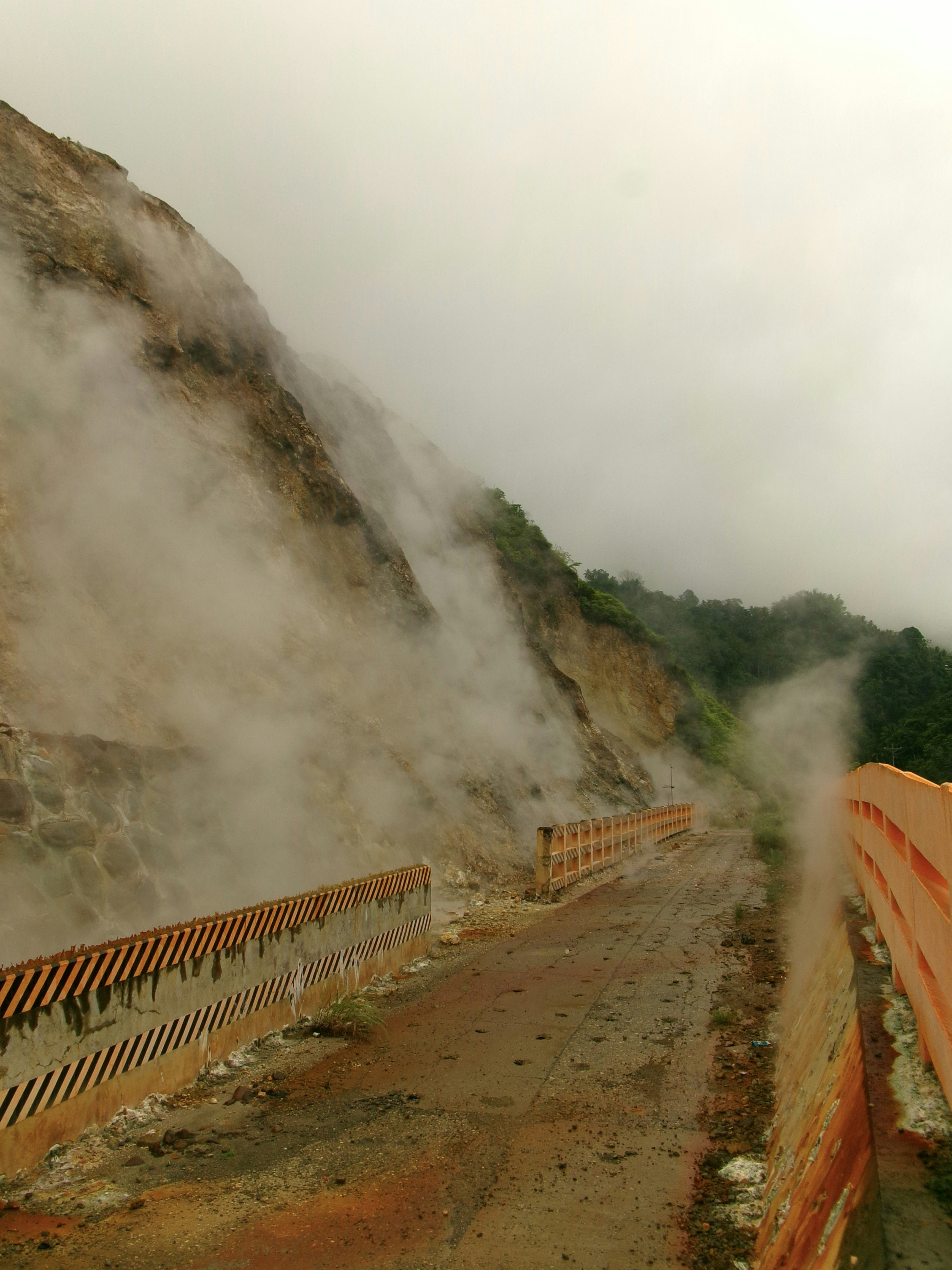 Misty Cliff Road Amid Orange Barricades