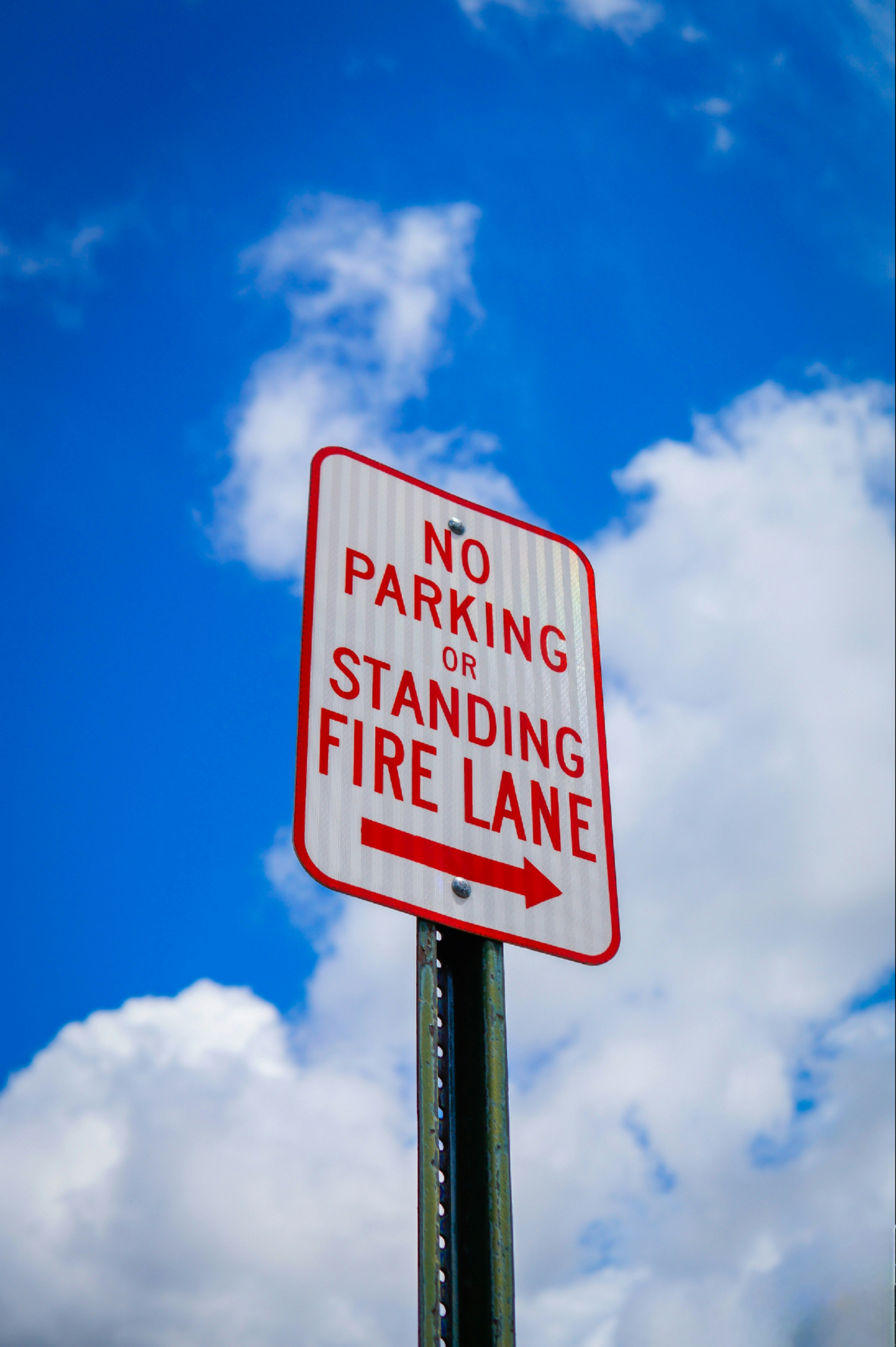 No Parking Sign, Bold Red Glyphs Against a Cerulean Sky