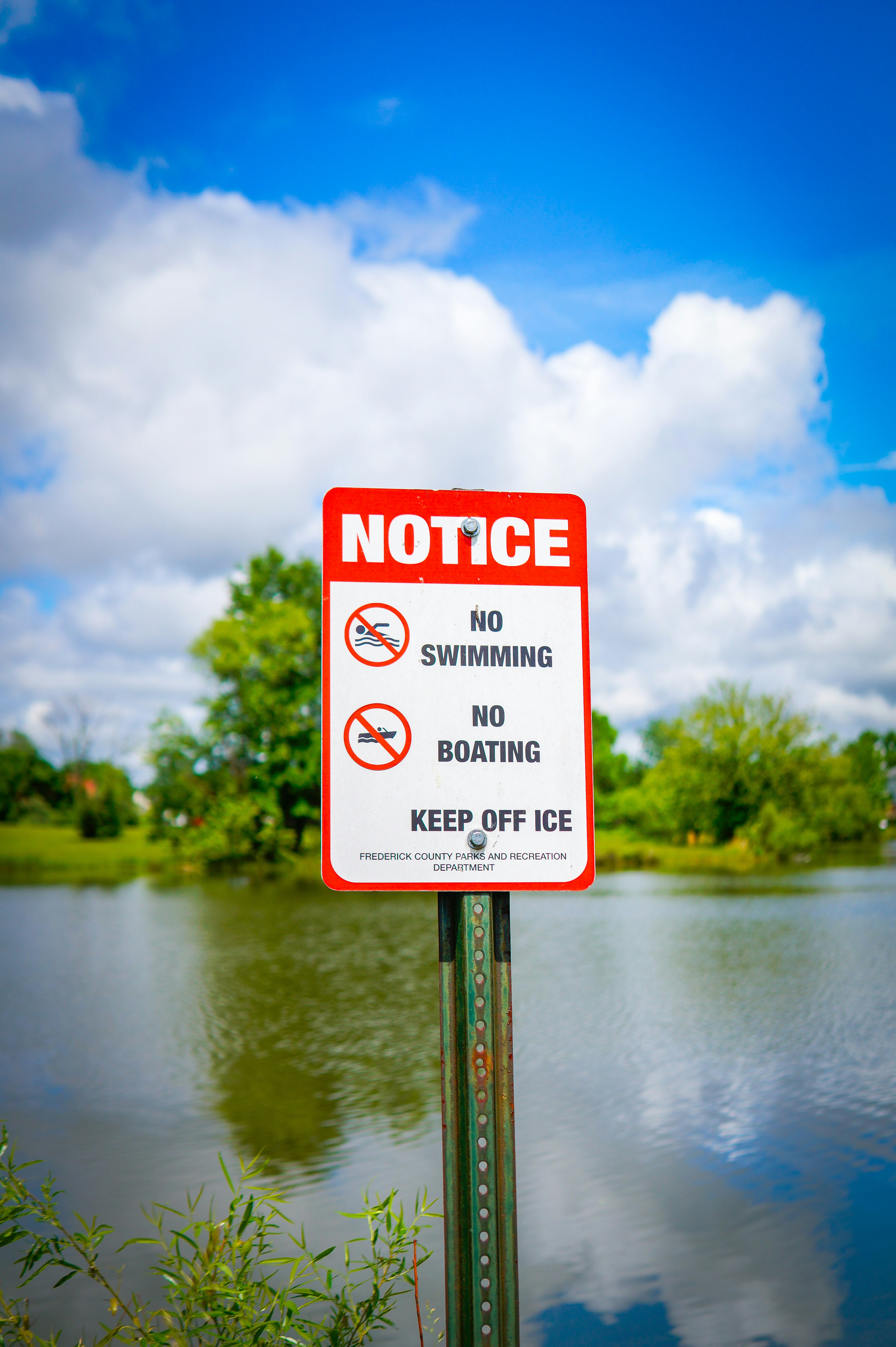Sign of Rules by the Water: A Warning Post with Lake Backdrop