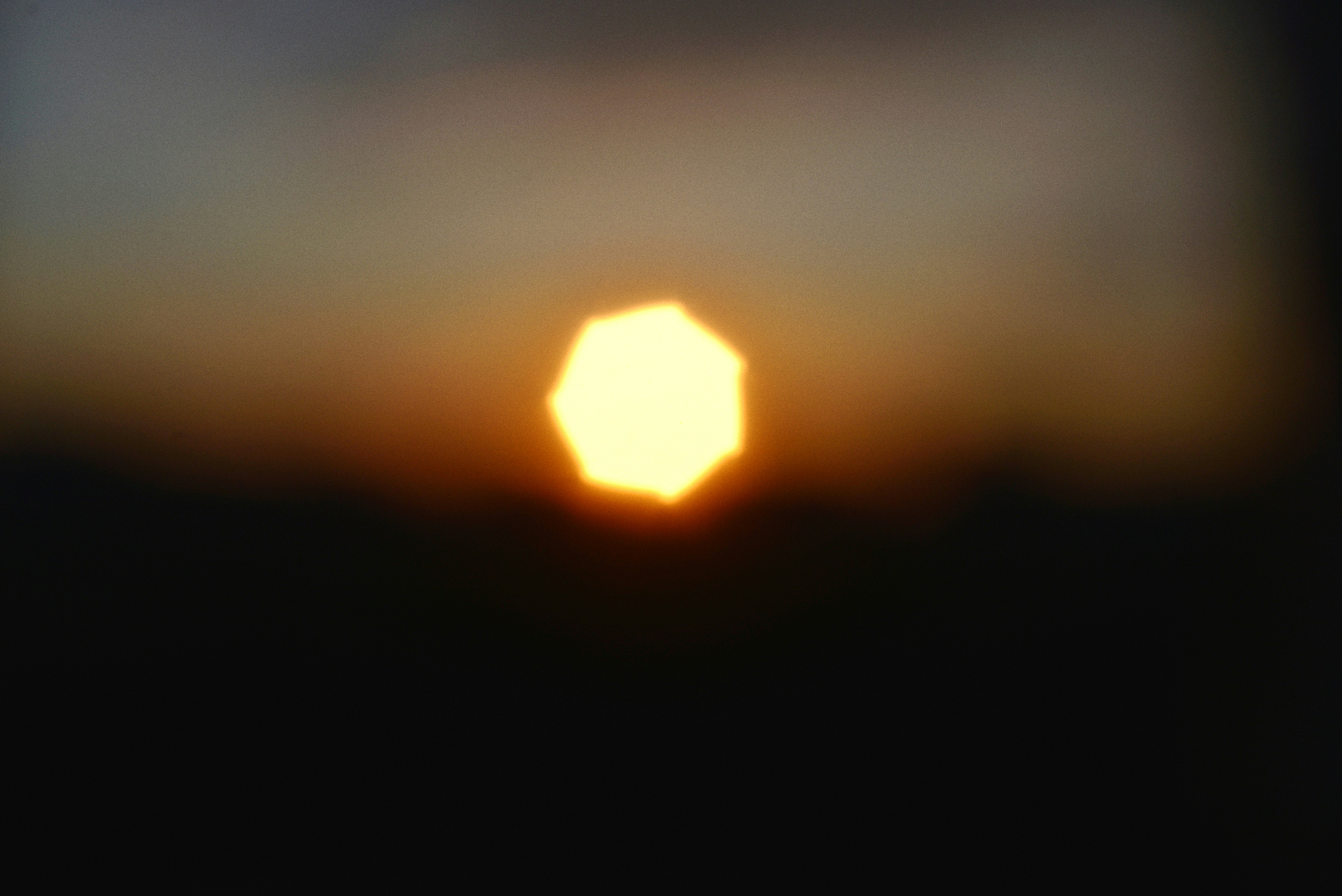 Blurry Horizon at Dusk: A Softly Glowing Sunlit Silhouette