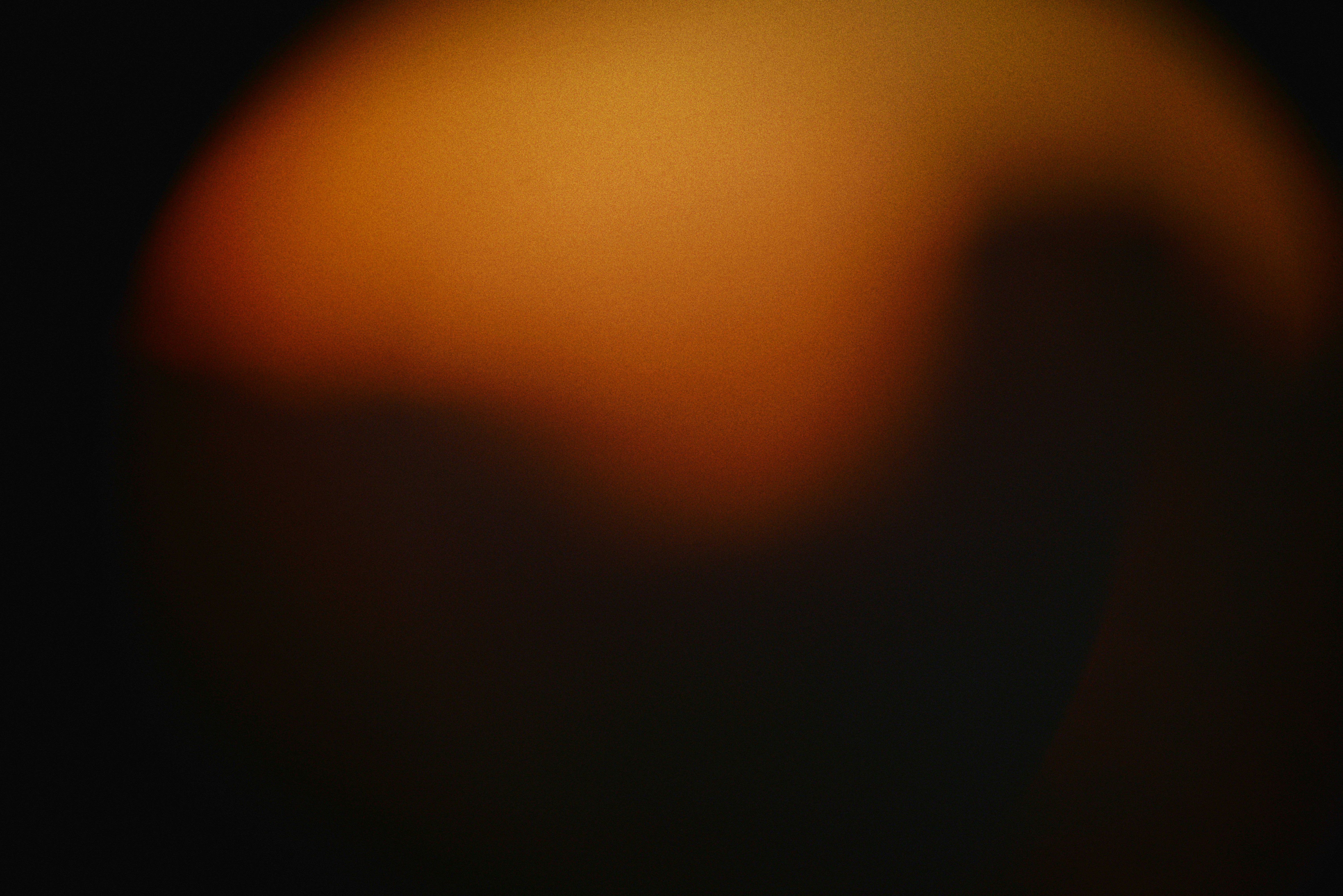 Orange Blur Over Horizon: A Dusk Silhouette, Veiled in Warm Haze