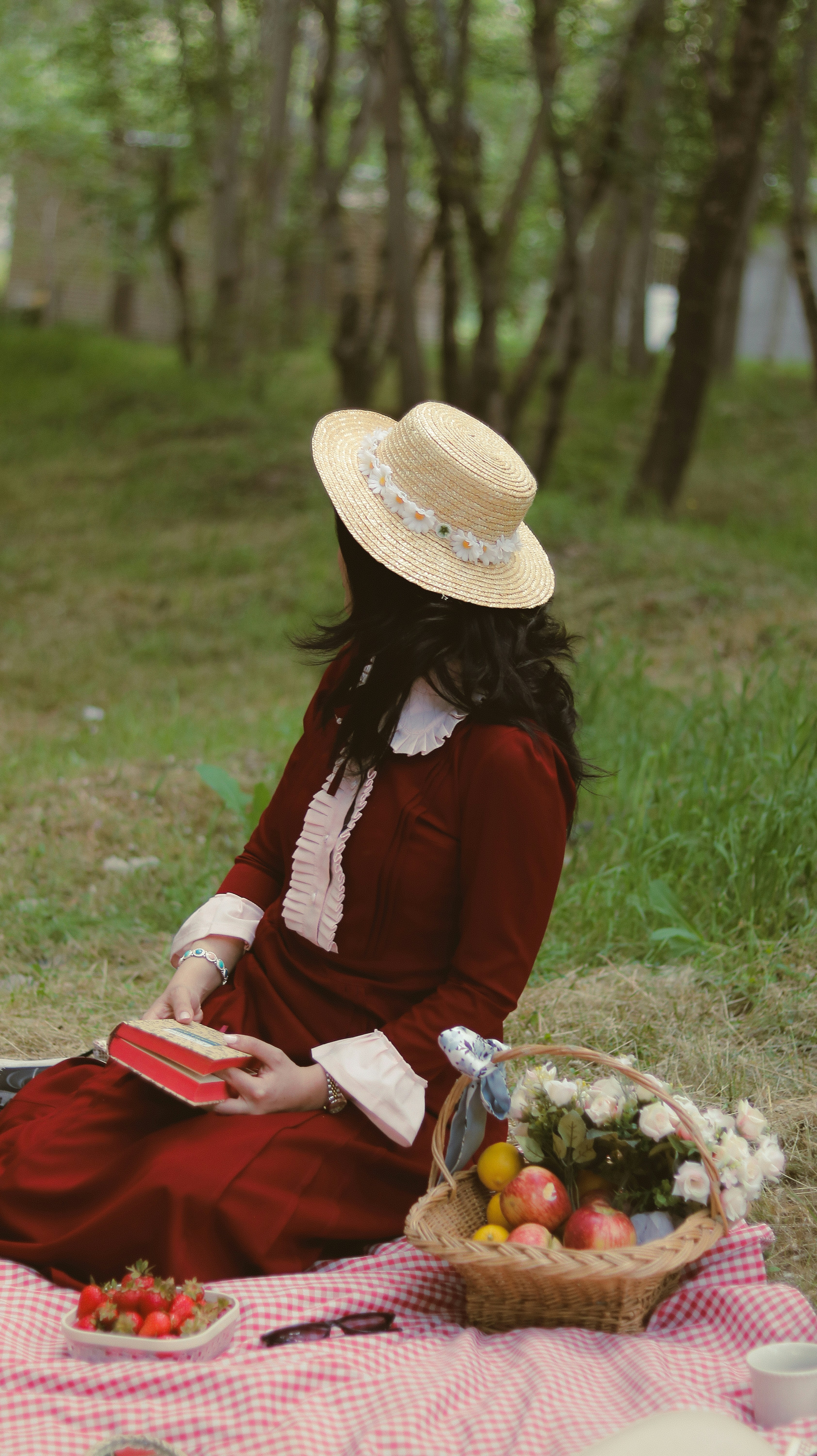 Picnic Daydream: A Woman in a Woolen Red Dress Amid a Quiet Park Picnic