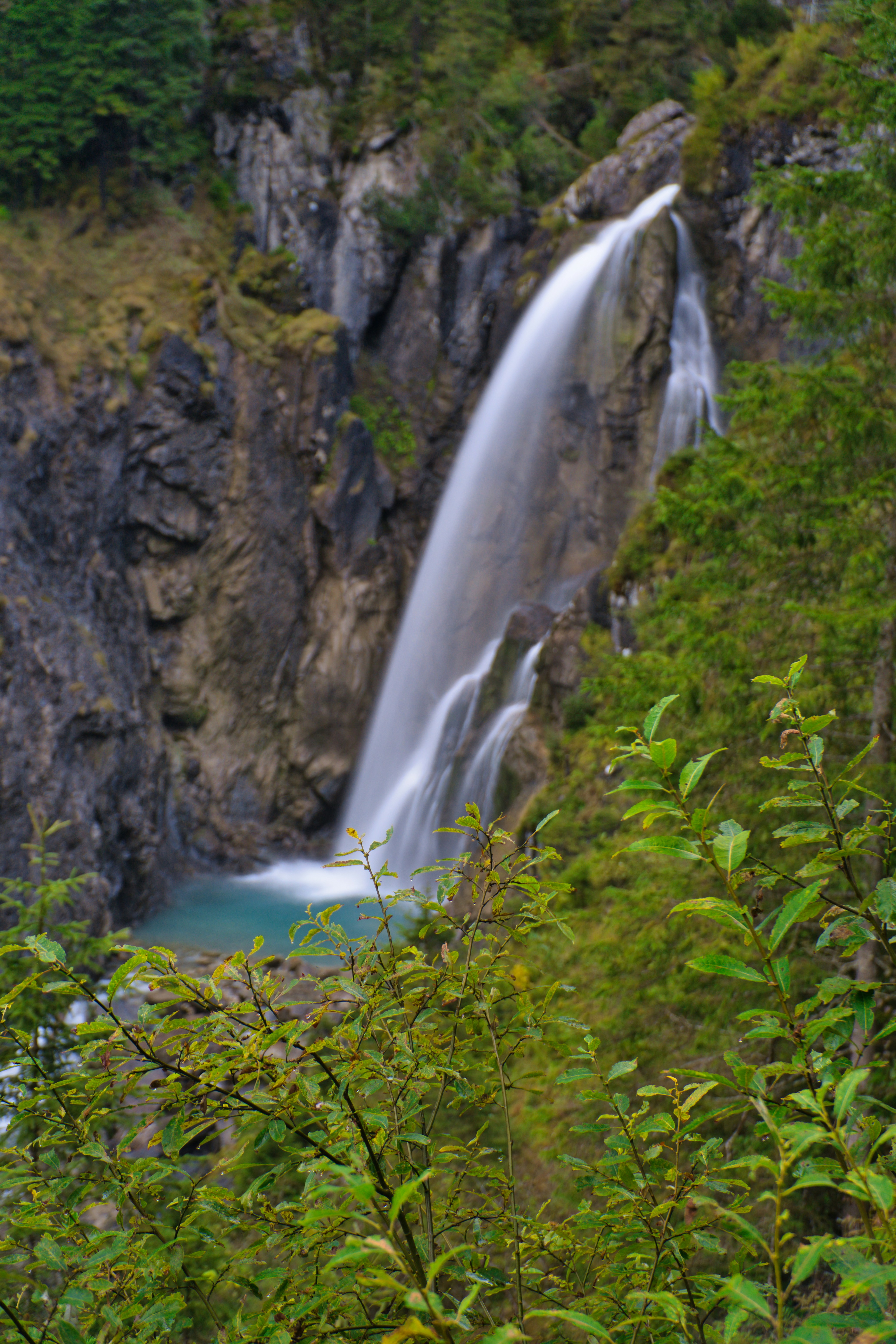 A Misty Cascade Surrounded by Emerald Foliage
