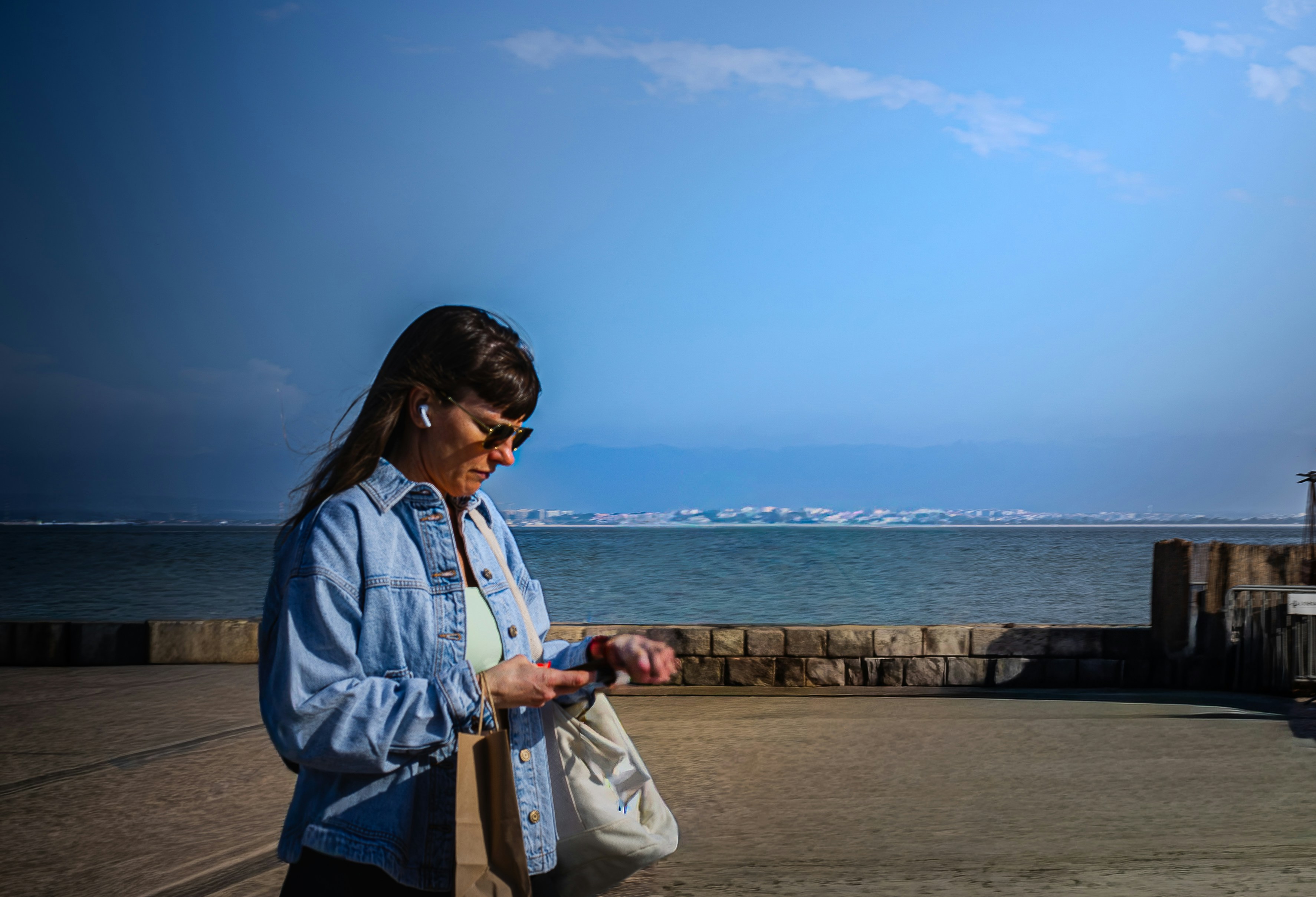 Coastal stroll with a phone in hand