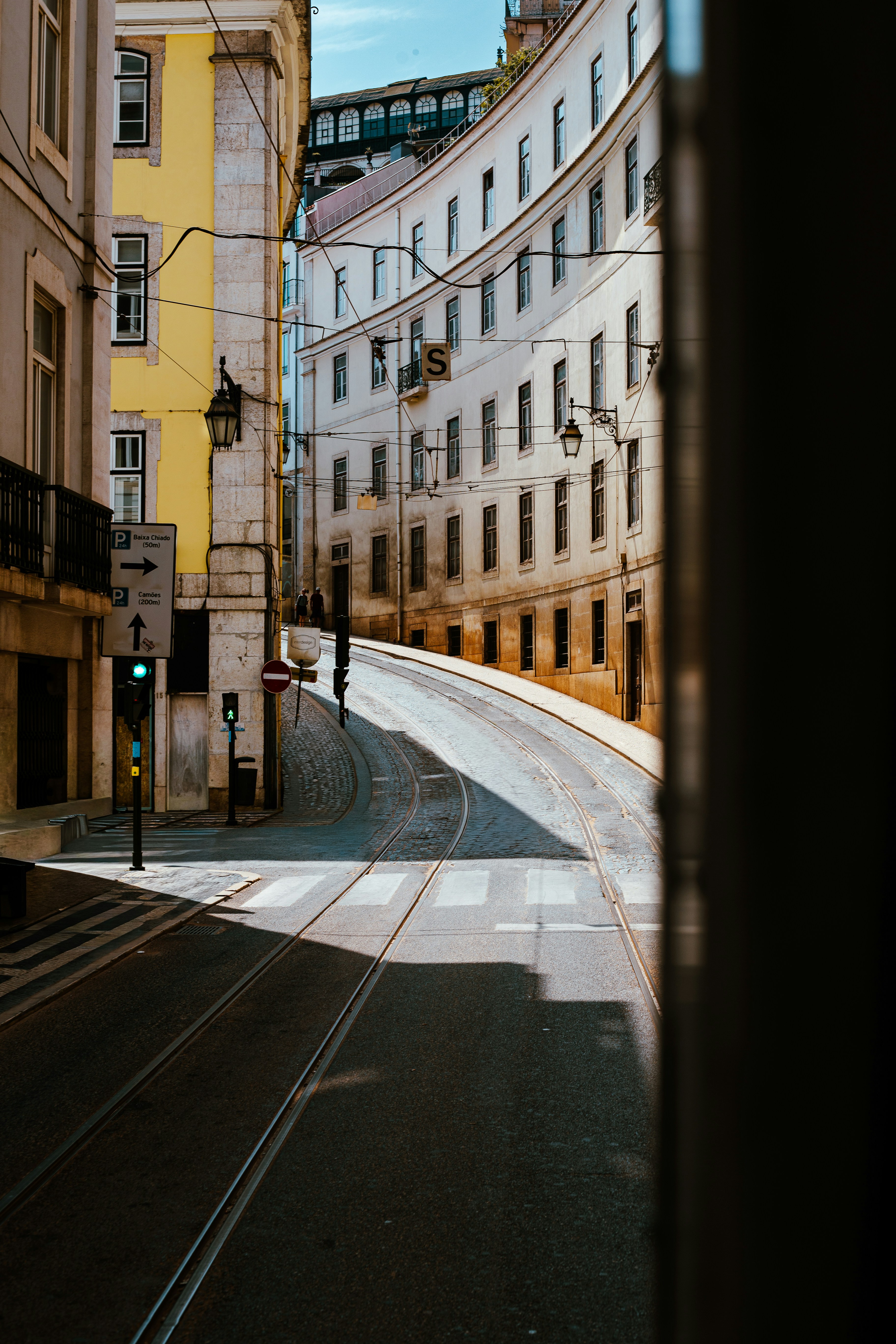 Curved Street Car Tracks Through a Sunlit European Alley