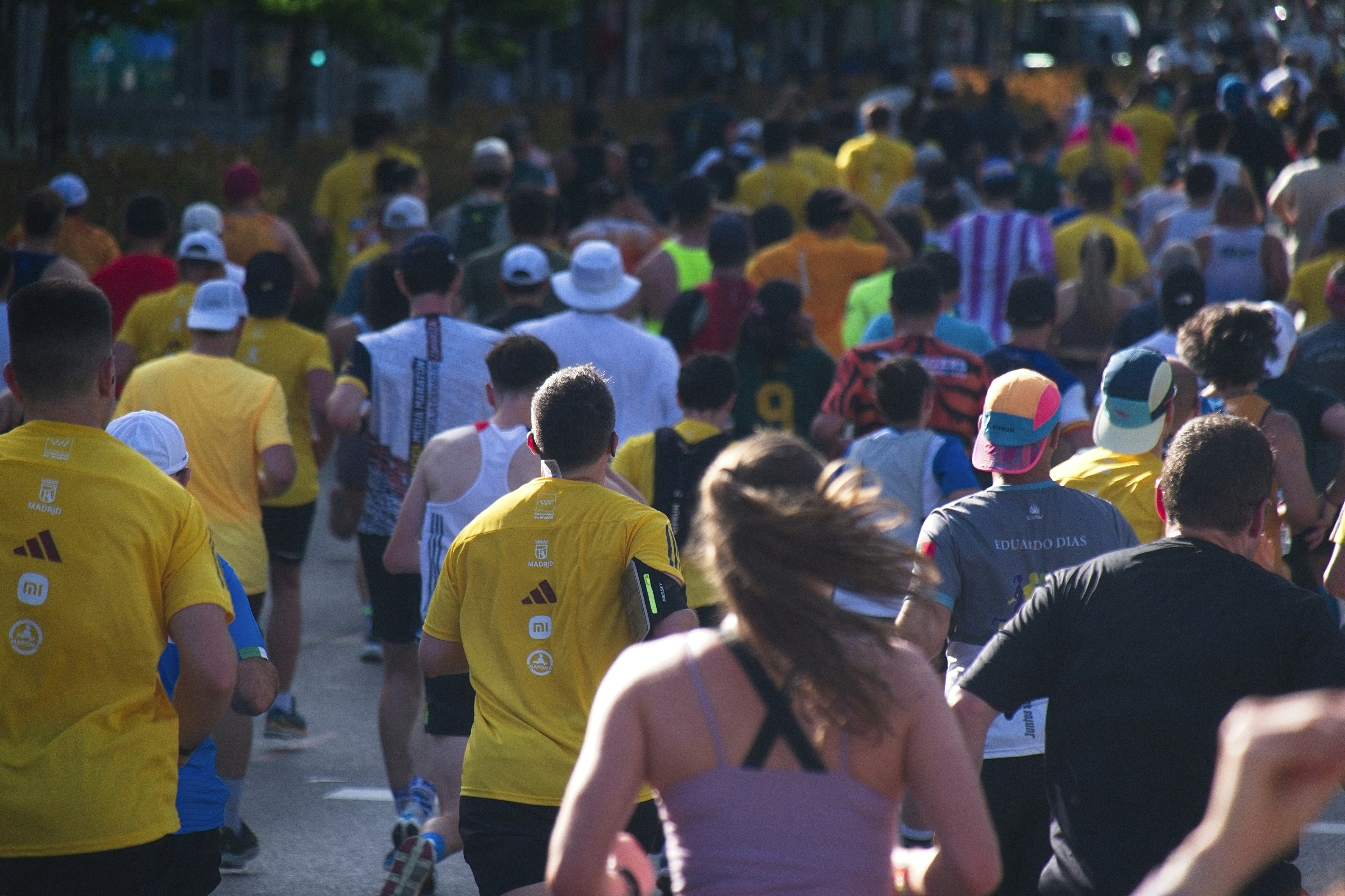 Numerous runners competing in a vibrant street race.