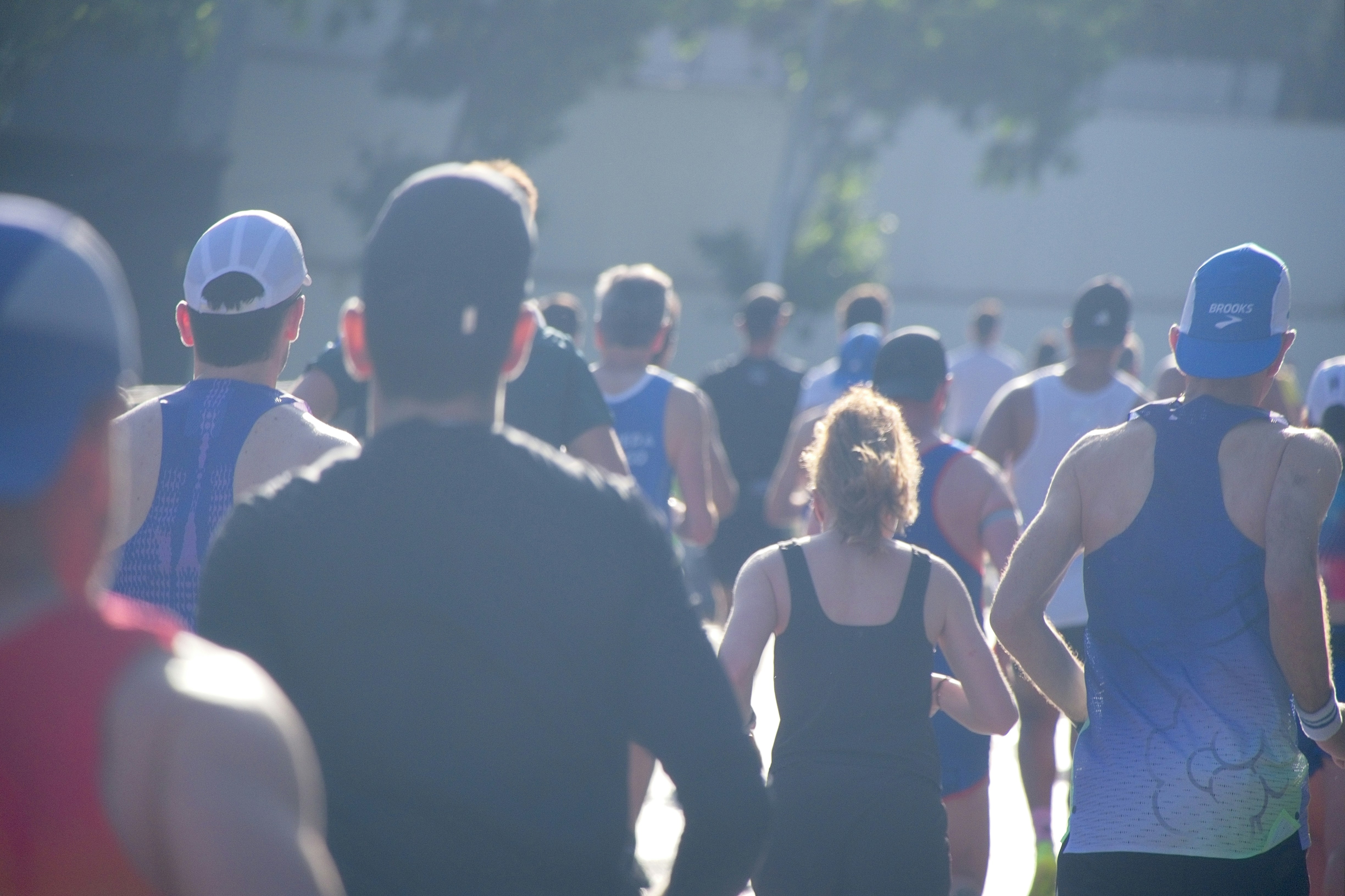 Crowd of runners converges at an early-morning race start