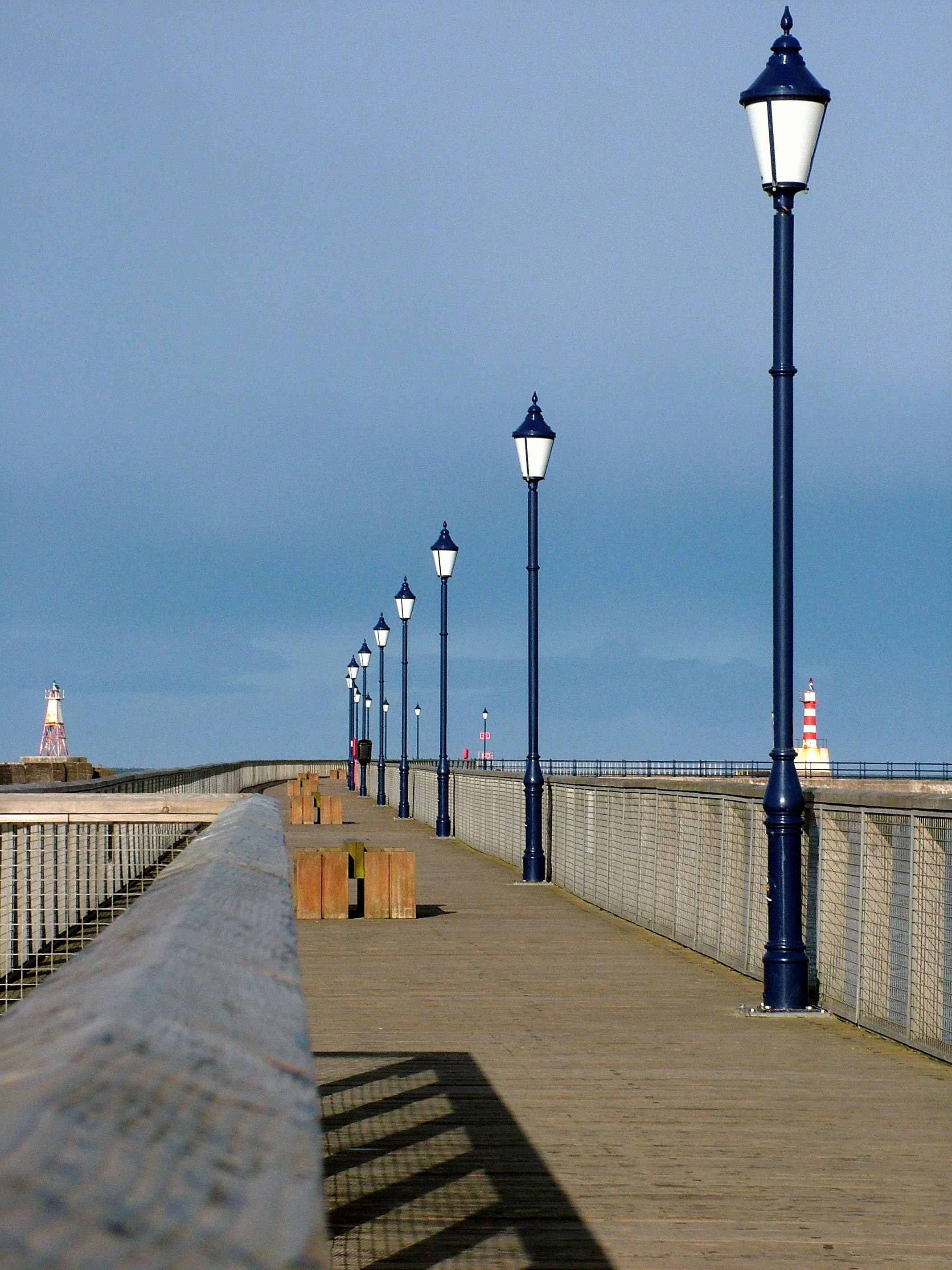 Blue-Column Promenade: Lanterns along a Quiet Pier