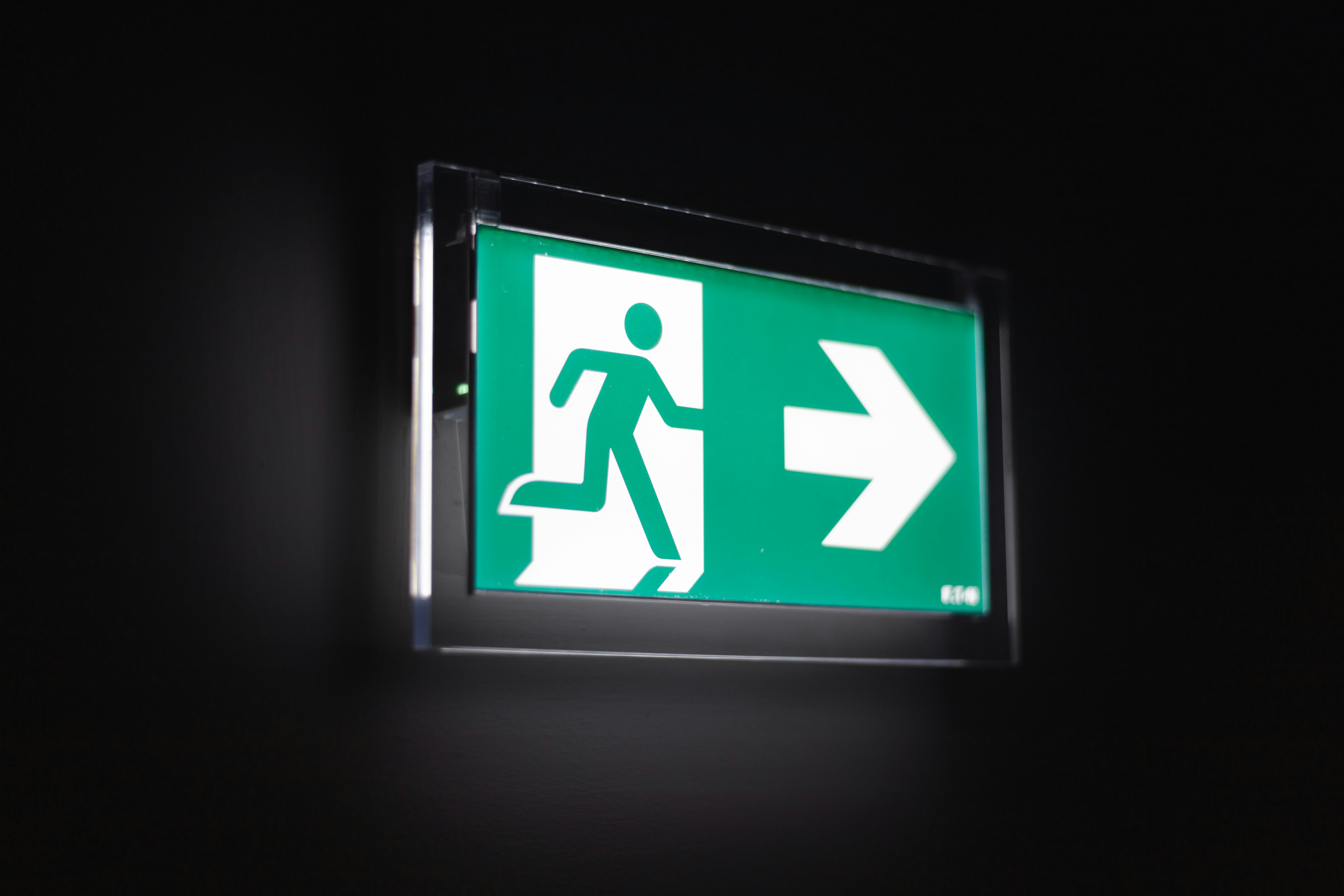 Green Exit: Illuminated Pathway Through the Darkness