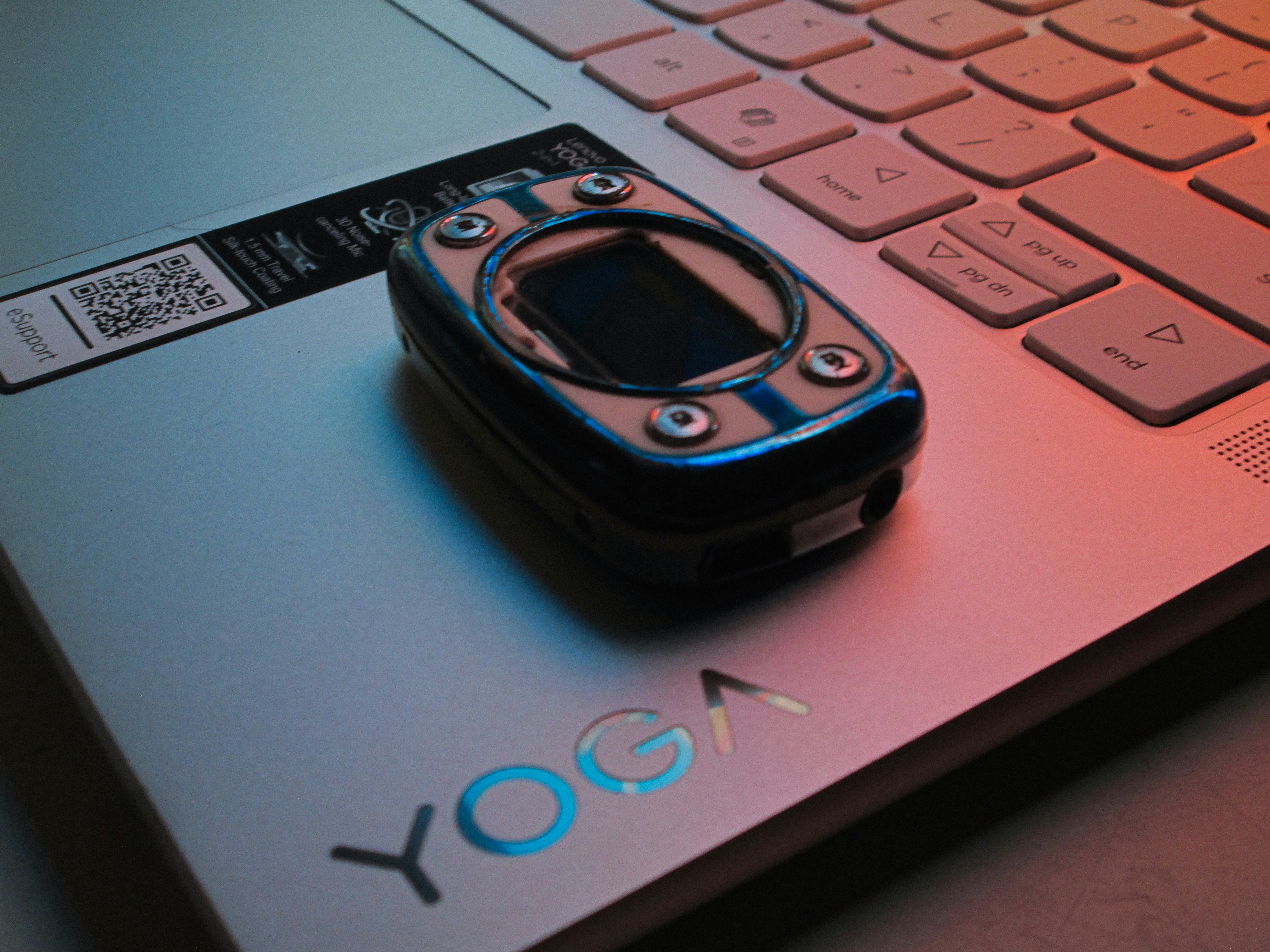 Pocket Tech: A Close-Up on the Vintage Device Resting on a Laptop
